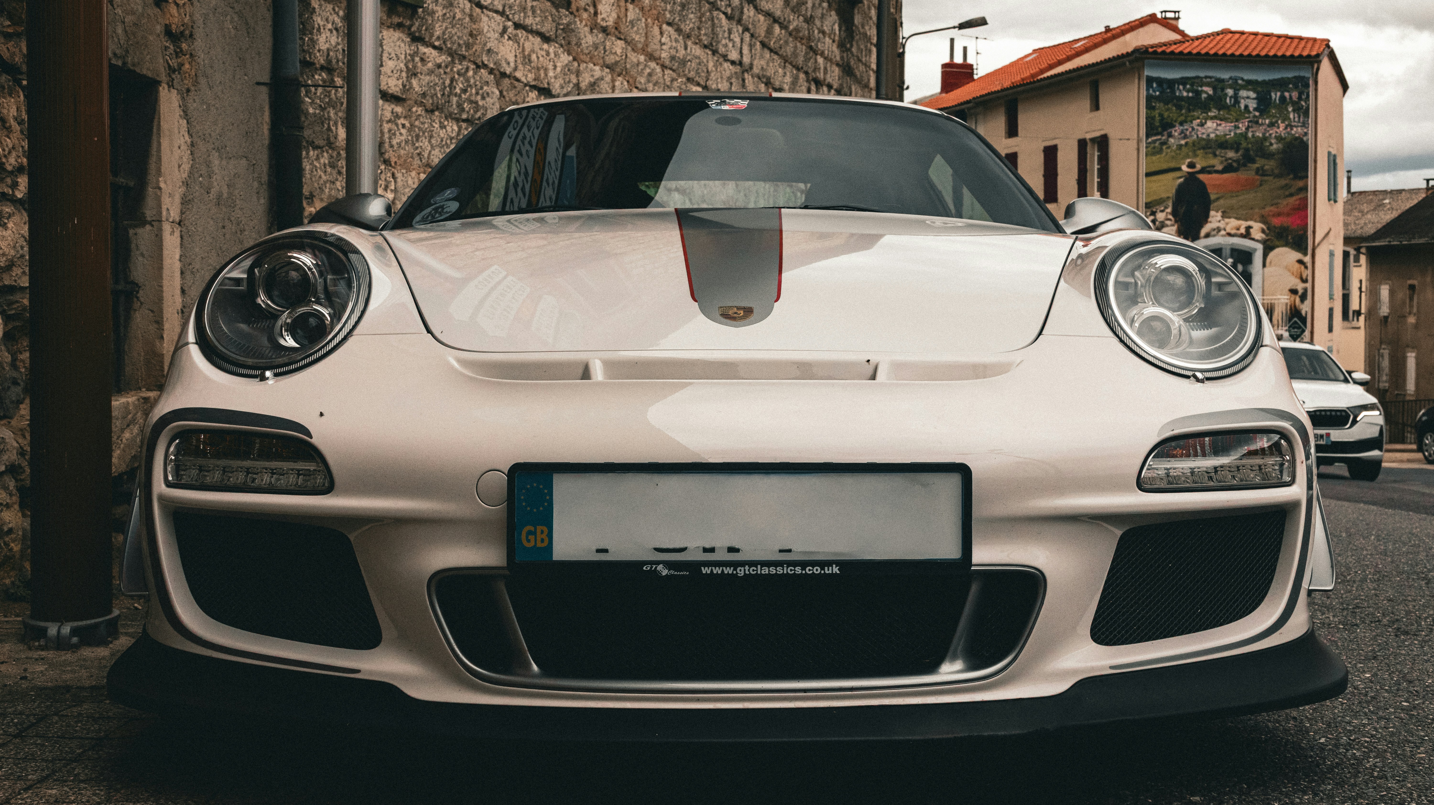White sports car parked on a street.