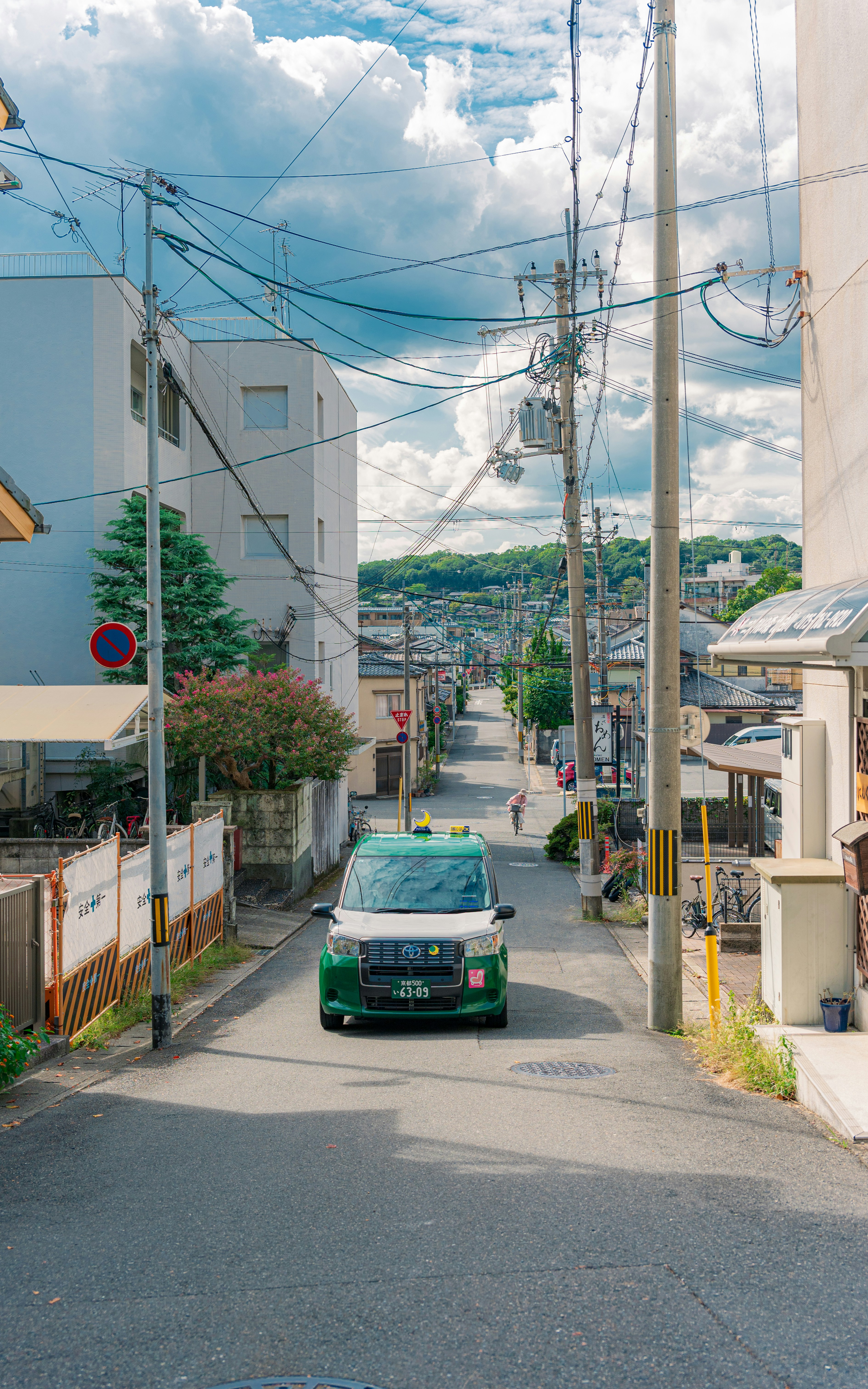 Urban Serenity: A Green Taxi's Journey Through Quiet Streets