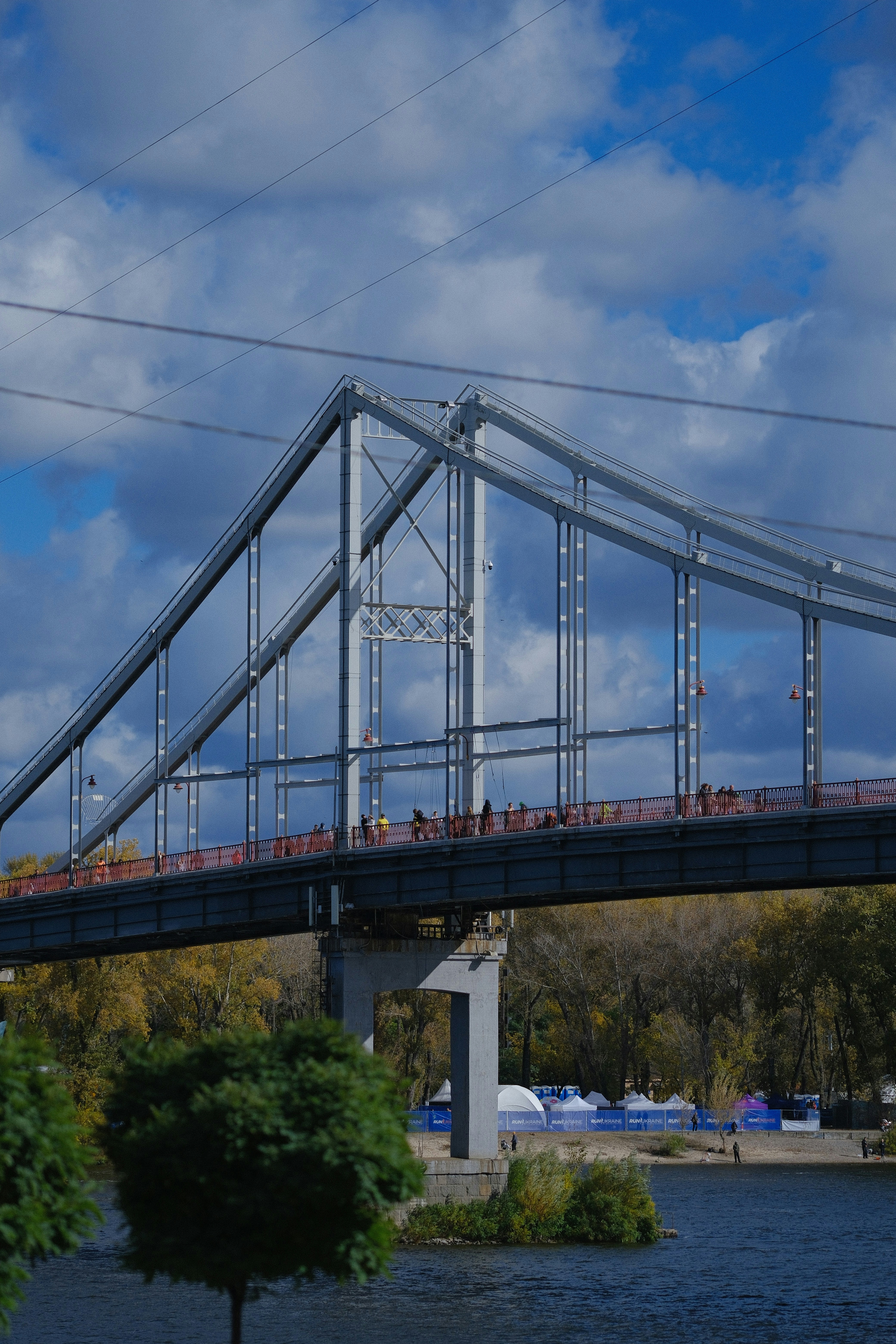 Pedestrian bridge with people walking across it