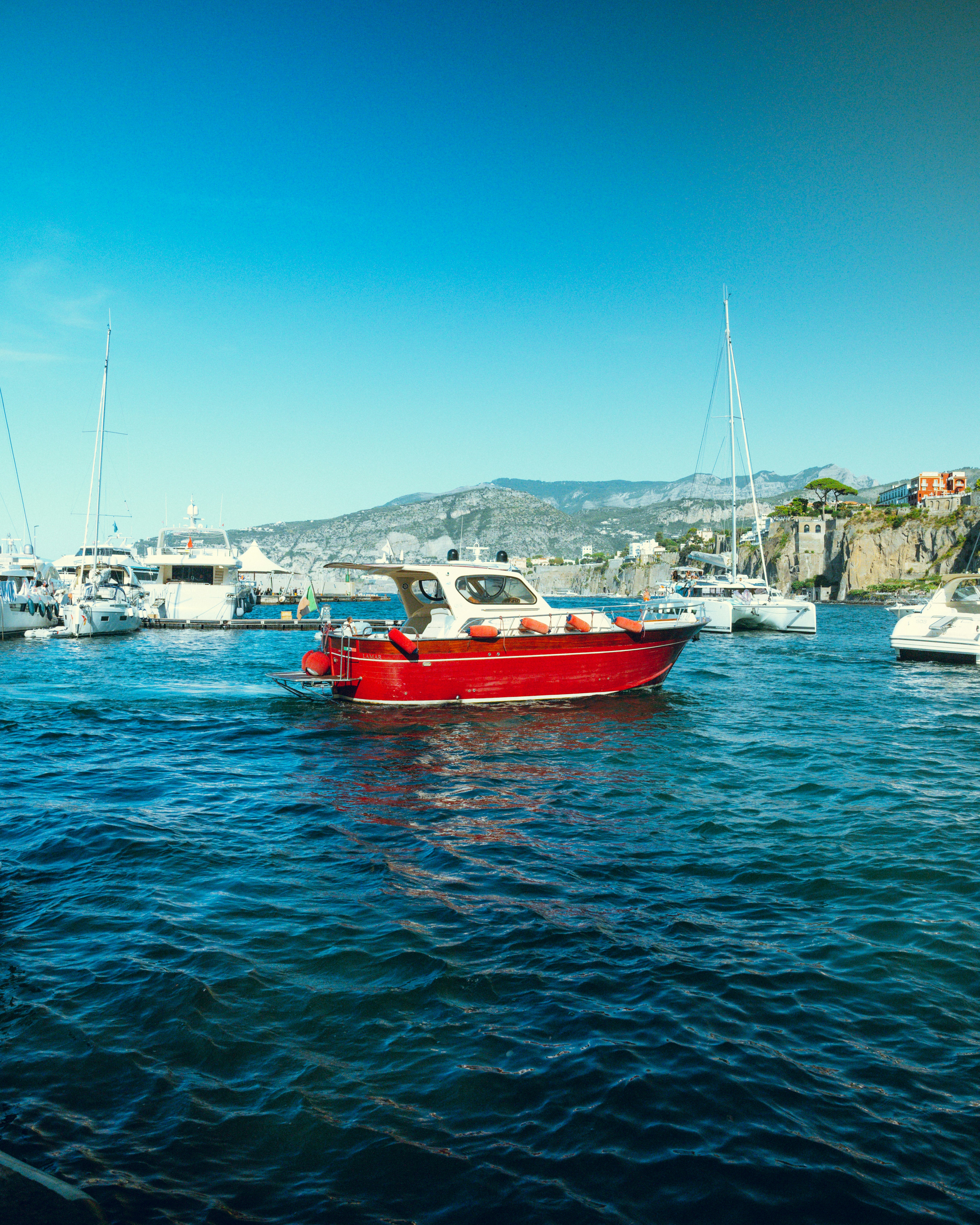 Crimson Cruiser Amidst Coastal Serenity