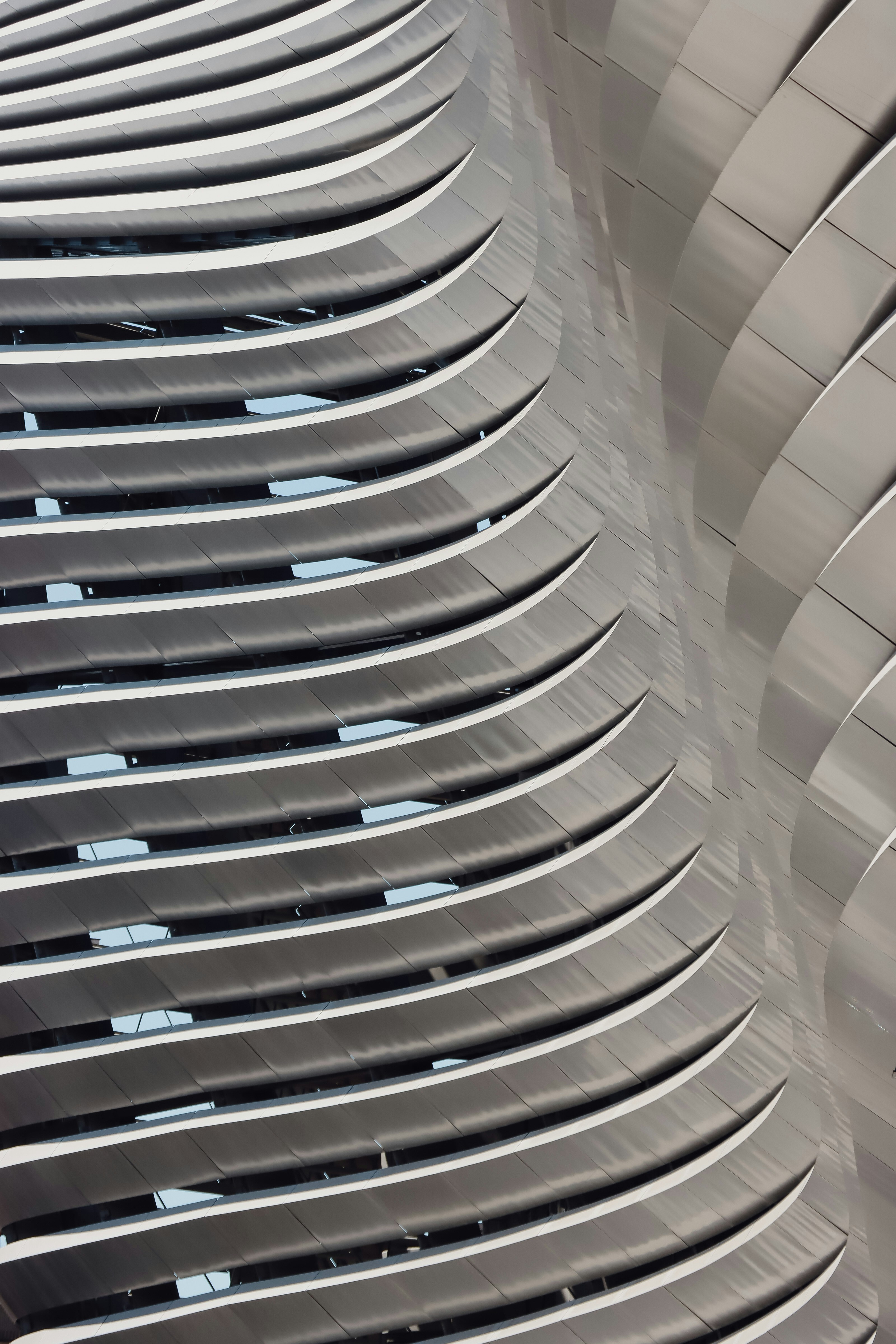 Modern building facade with curved metallic louvers