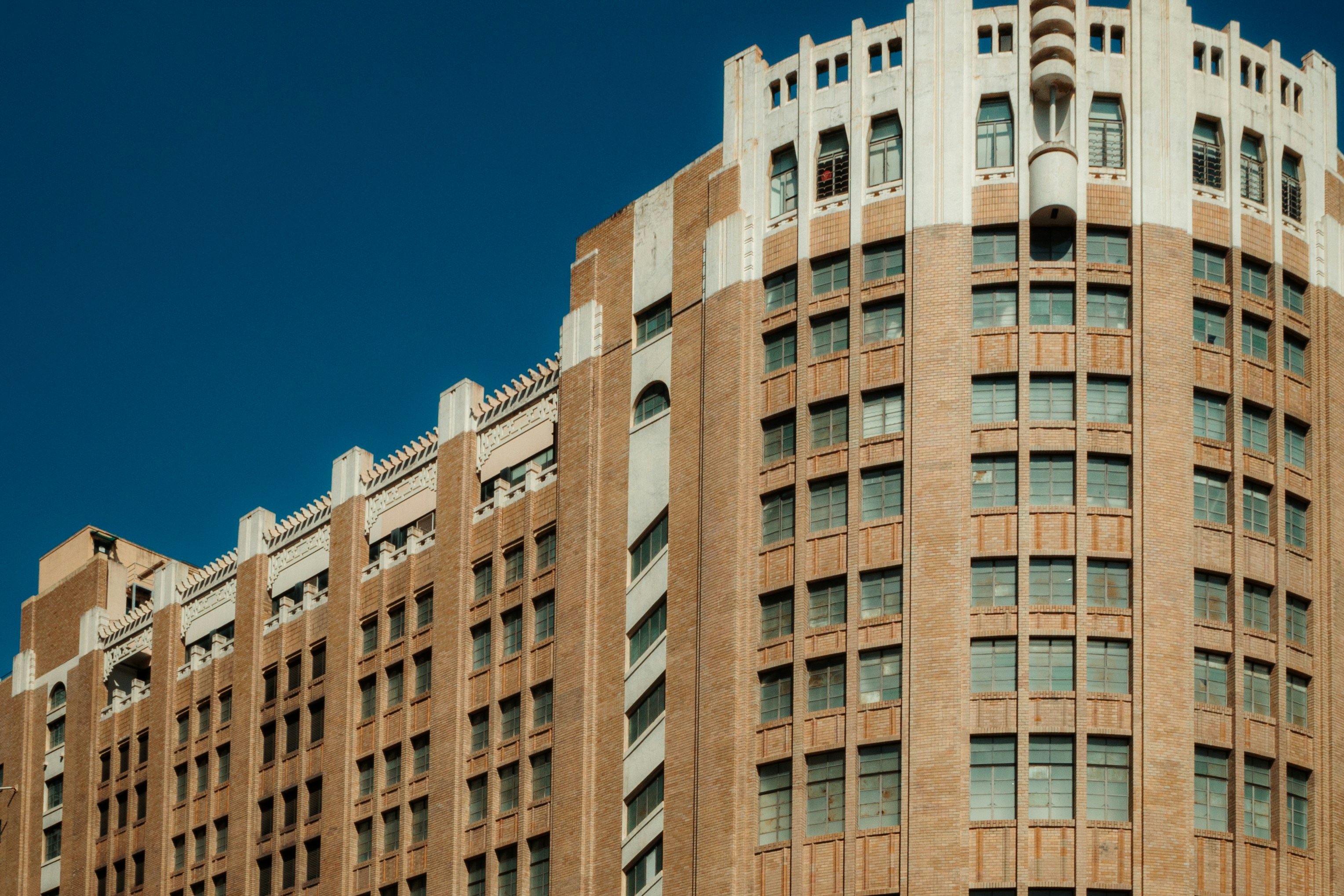 Tall art deco building against a clear blue sky