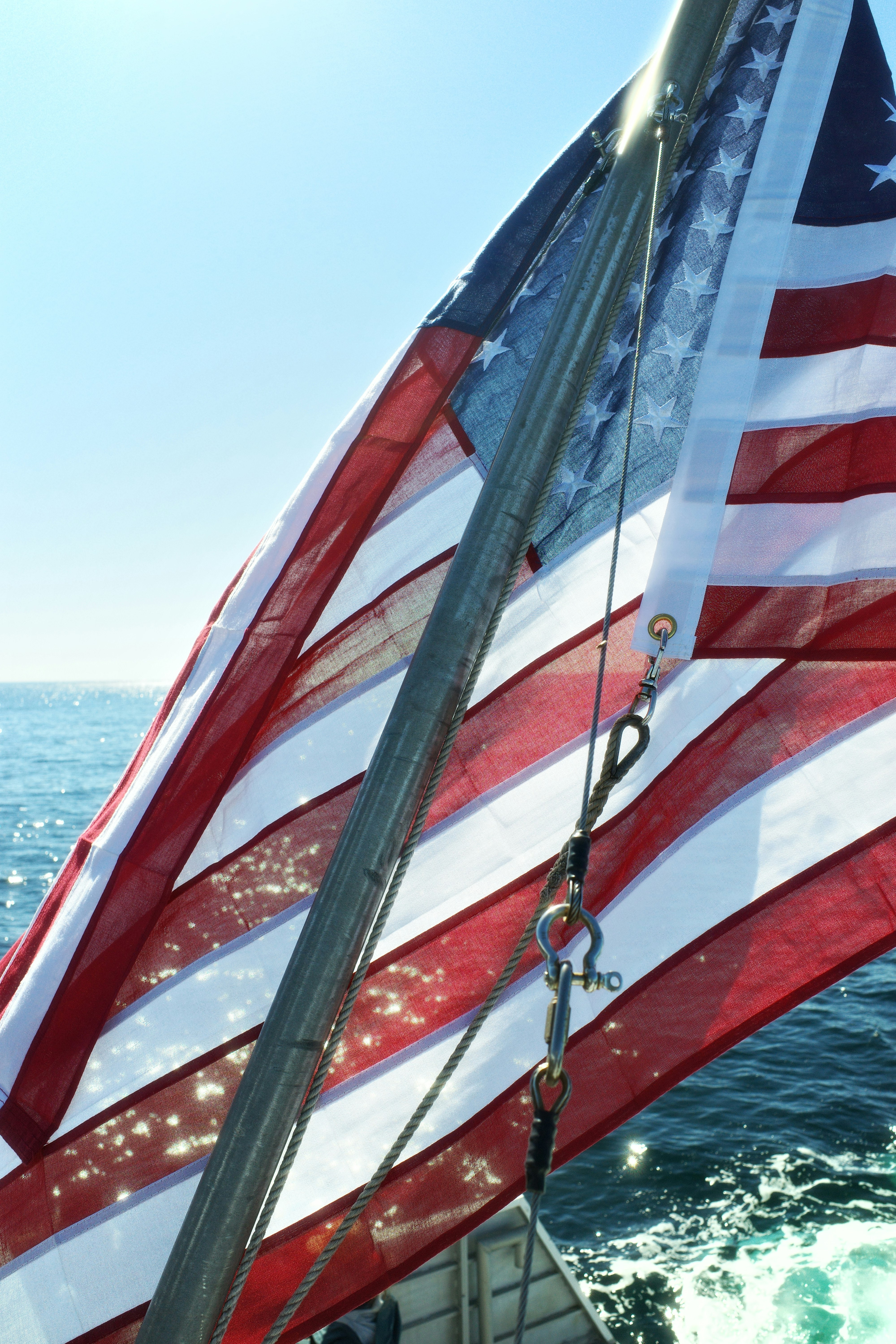 American flag waving on a boat at sea