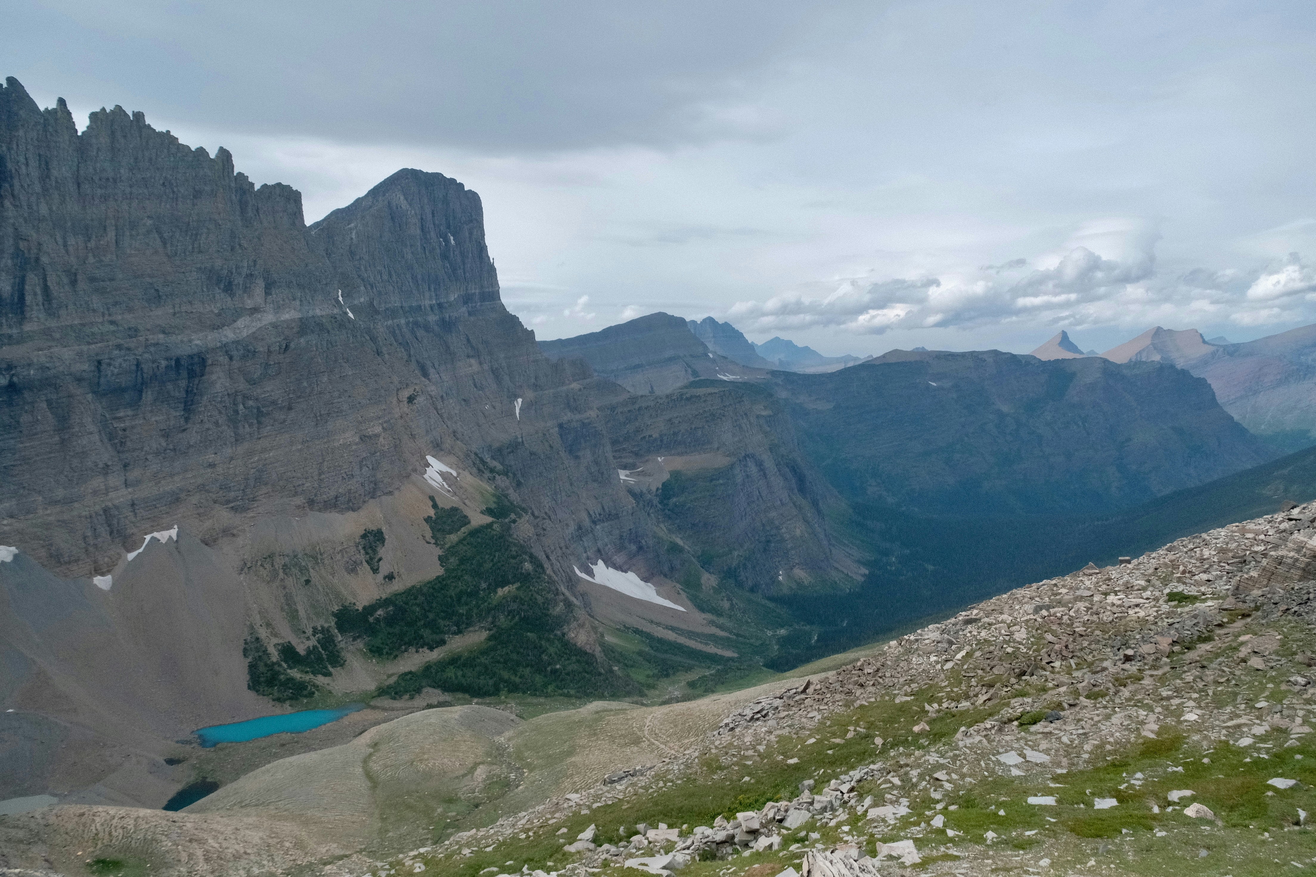 Rugged mountain range with a small turquoise lake