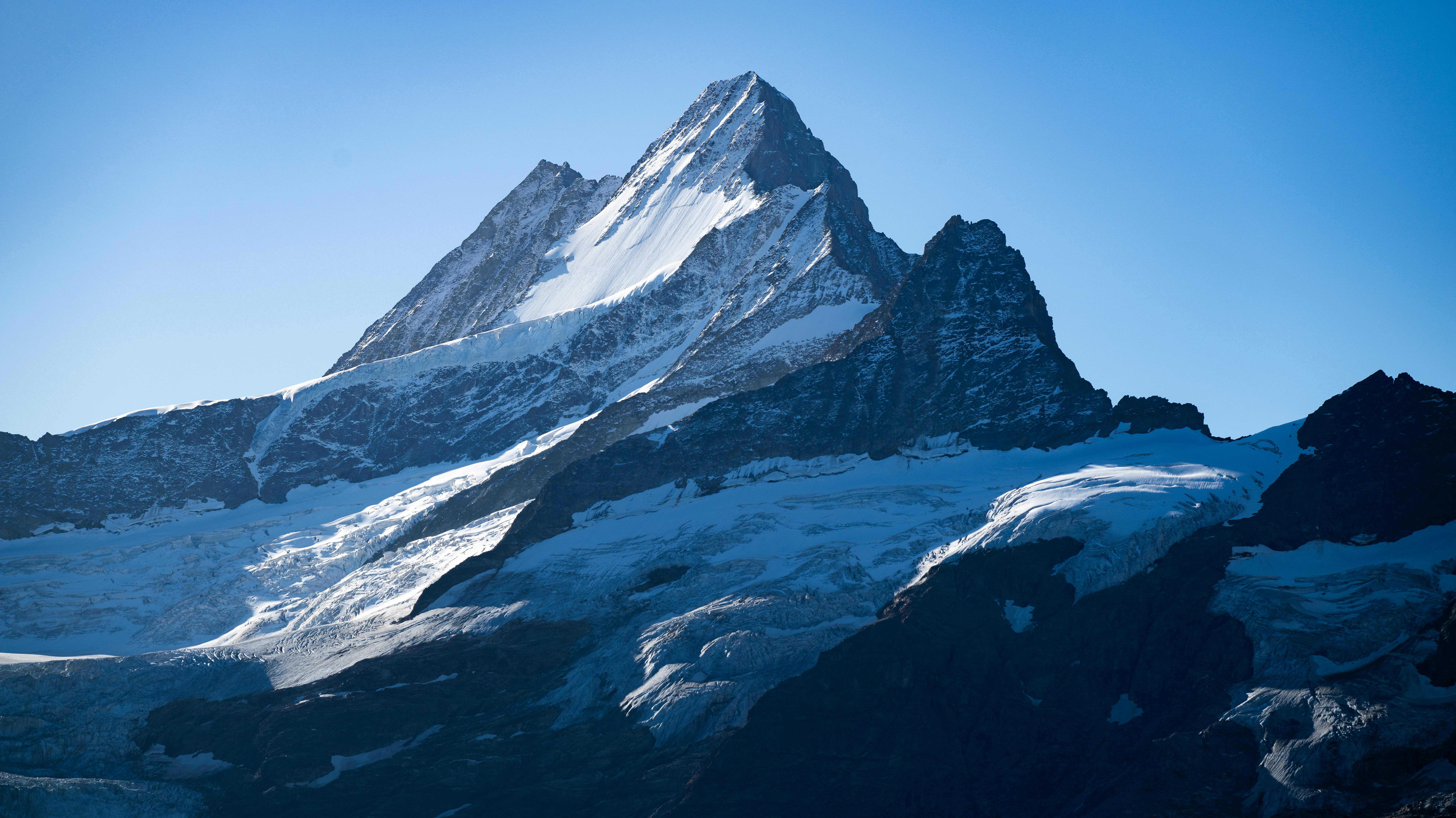Snow-capped mountain peak under a clear blue sky