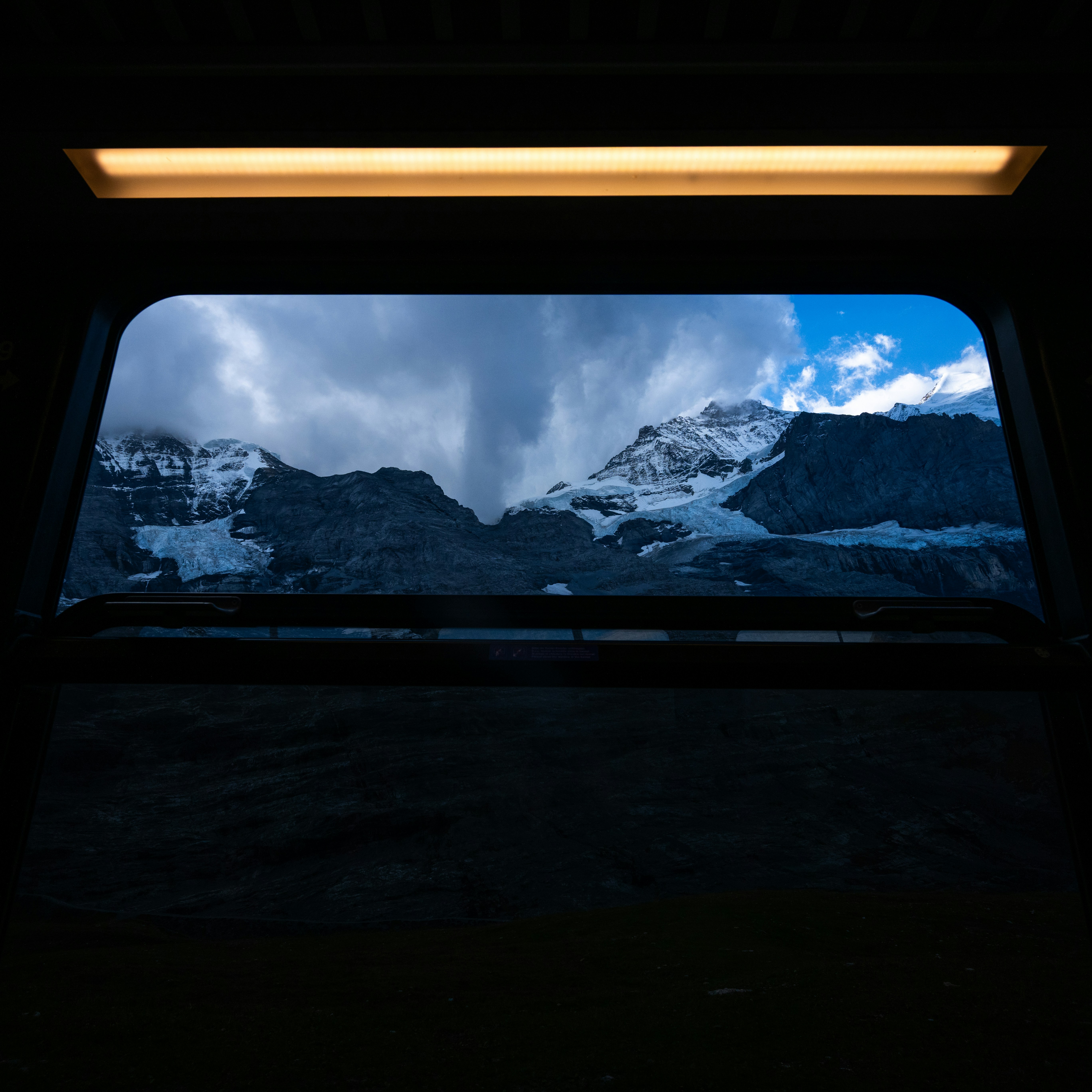 Blue Hour Summit Framed by a Dark Vehicle Window