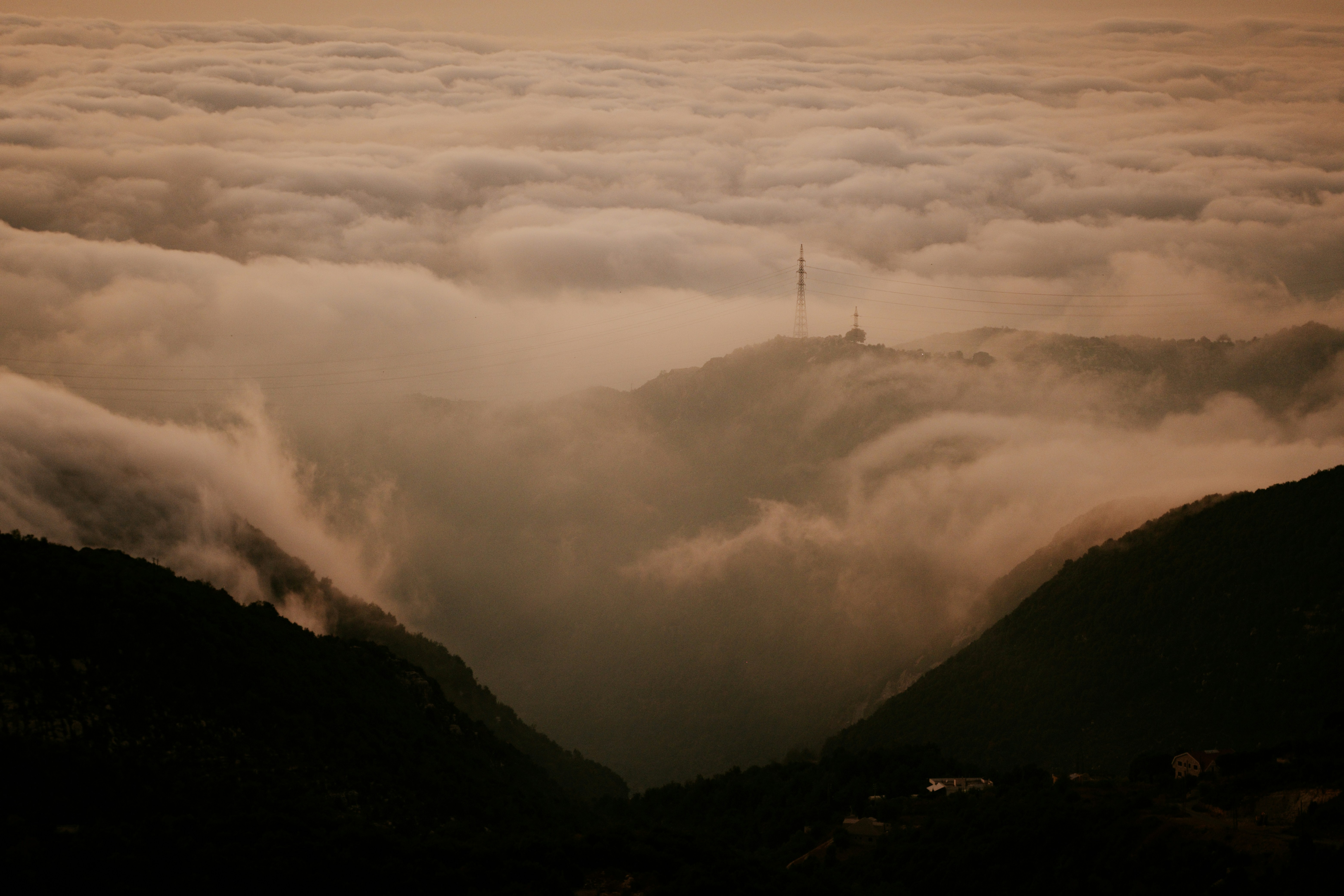 Mountain peaks emerge from a sea of clouds.