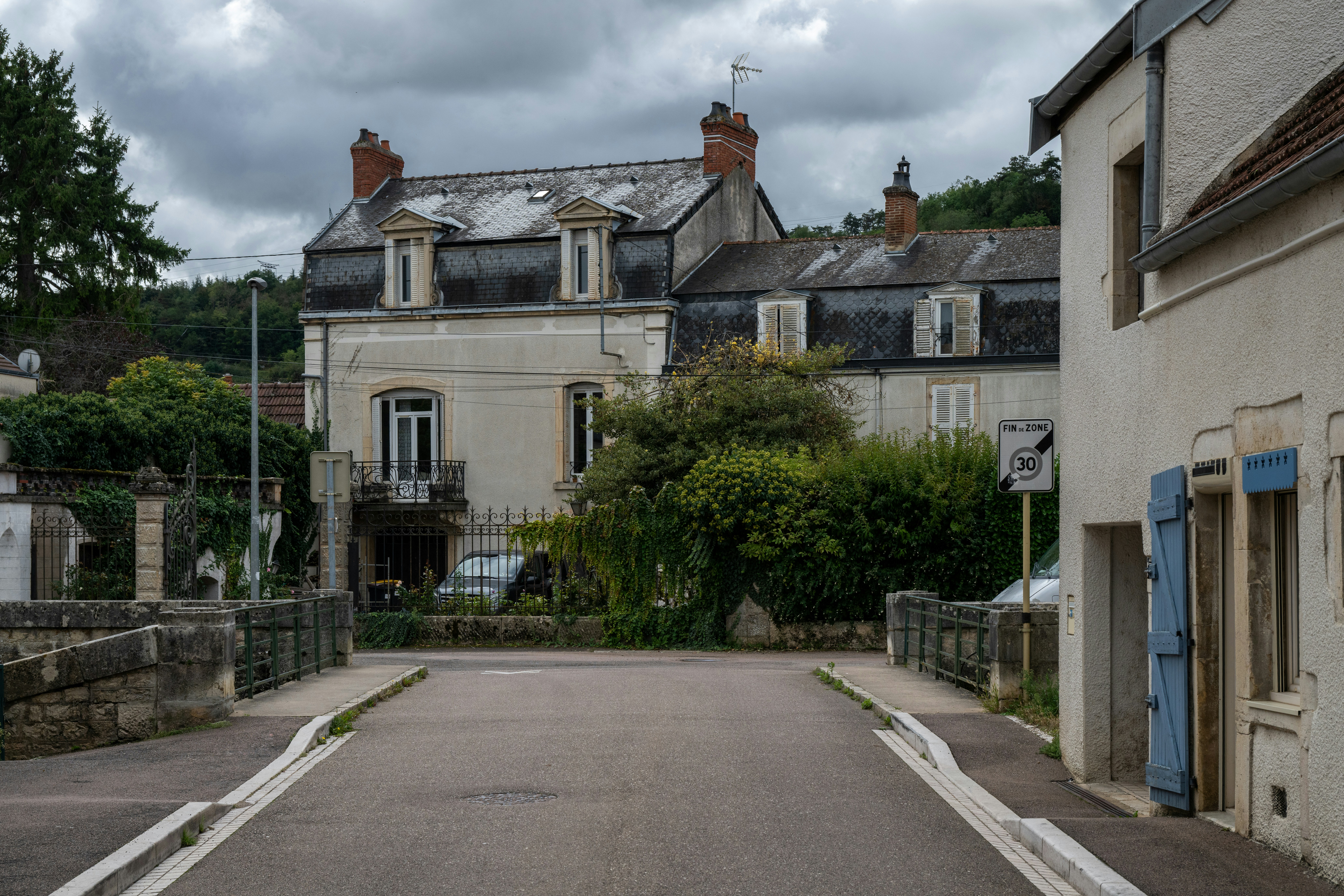 Pathway to a Weathered Manor Under Leaden Skies