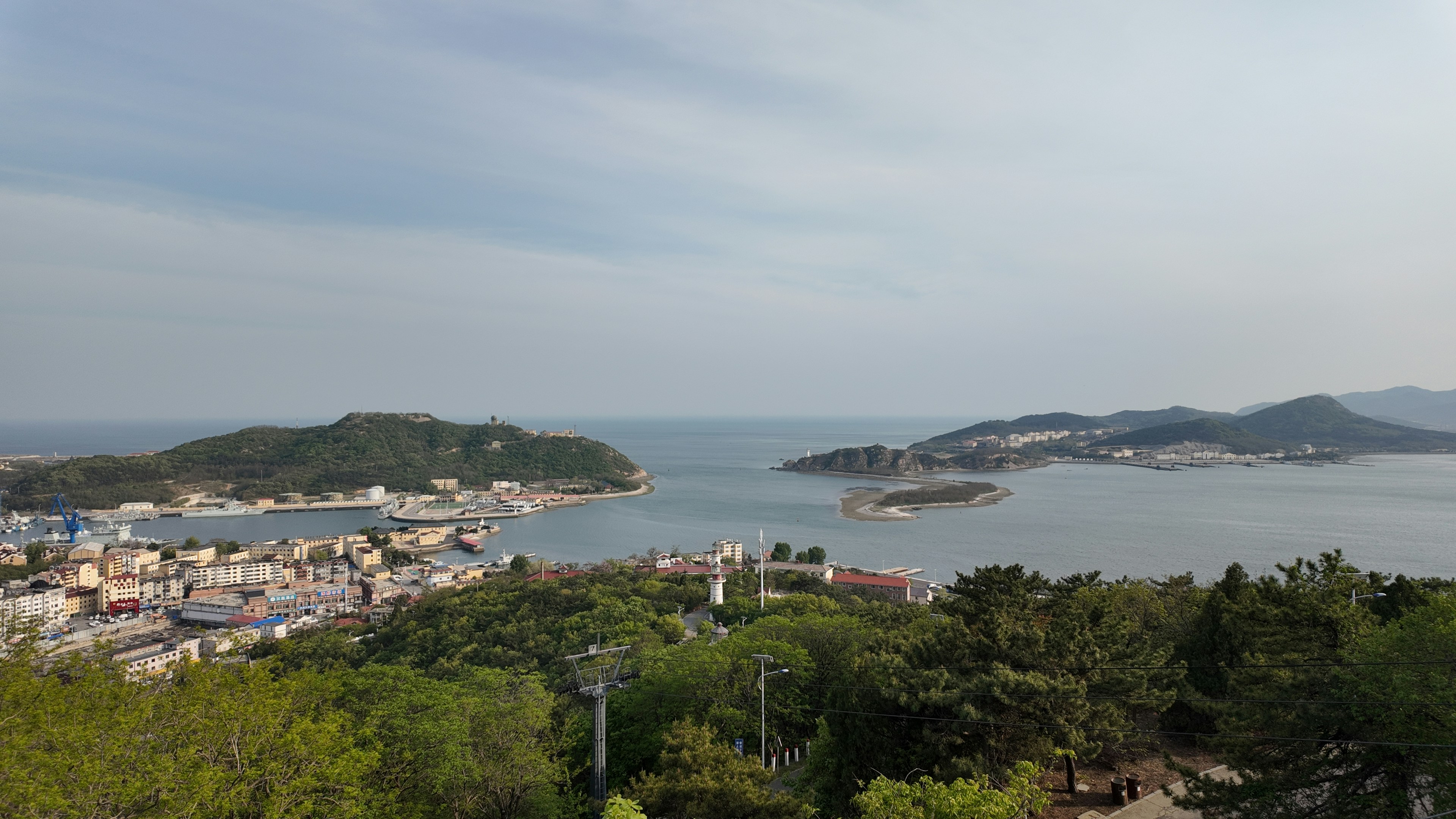 Coastal town with harbor and islands in distance
