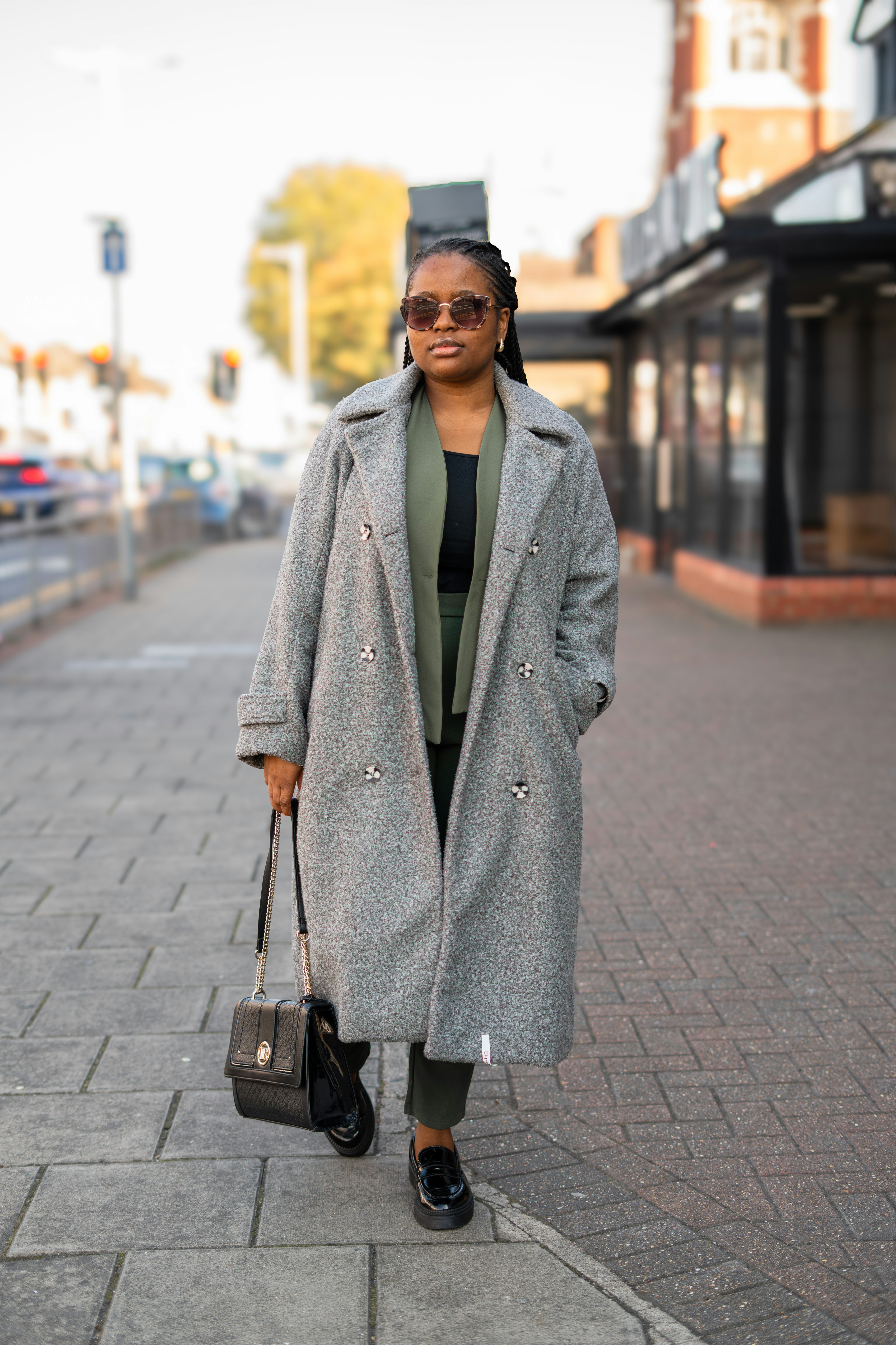 Woman Walking | Woman in grey coat walks on sidewalk