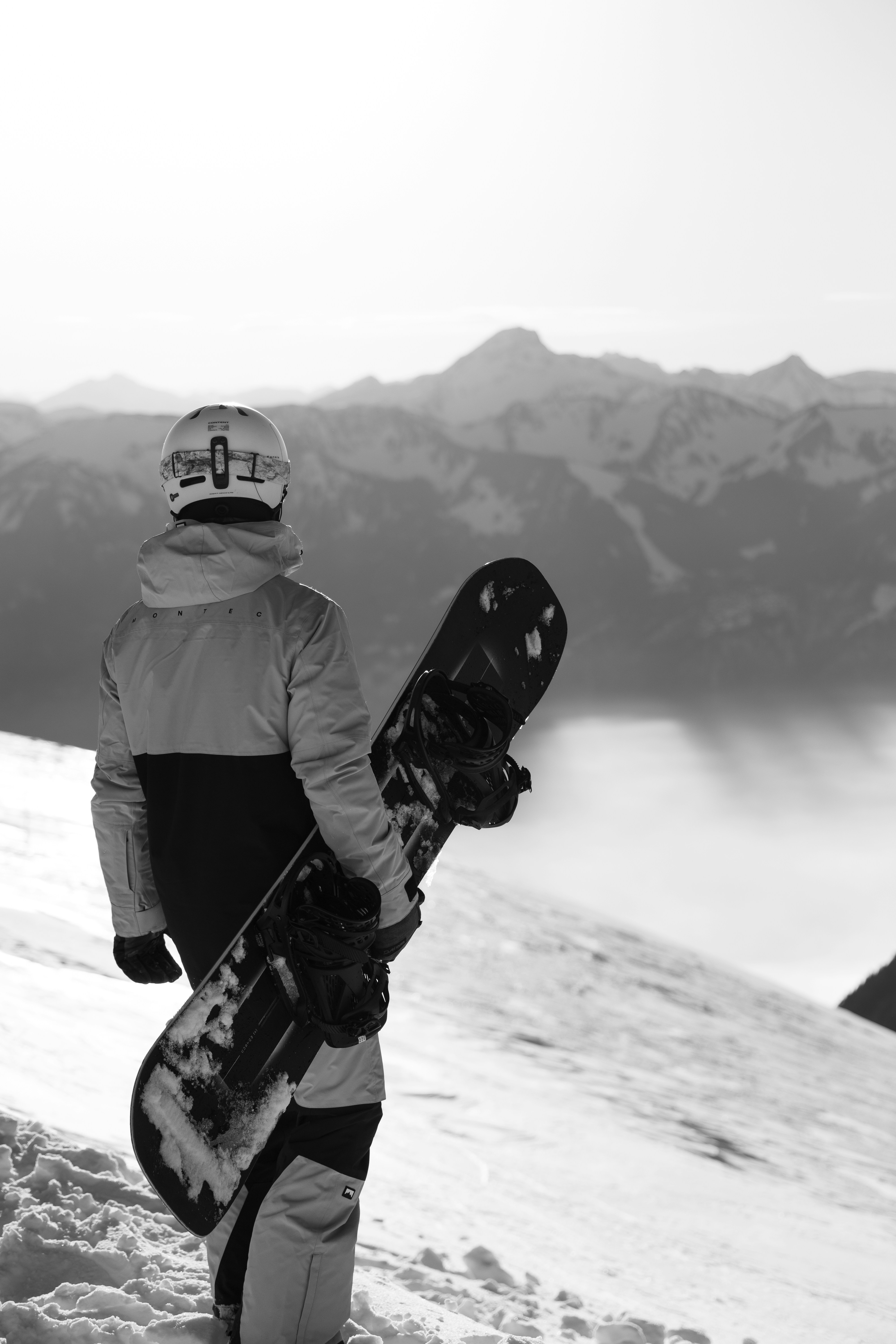 Back to the Ridge: Snowboarder Pauses at the Edge of Winter Silence