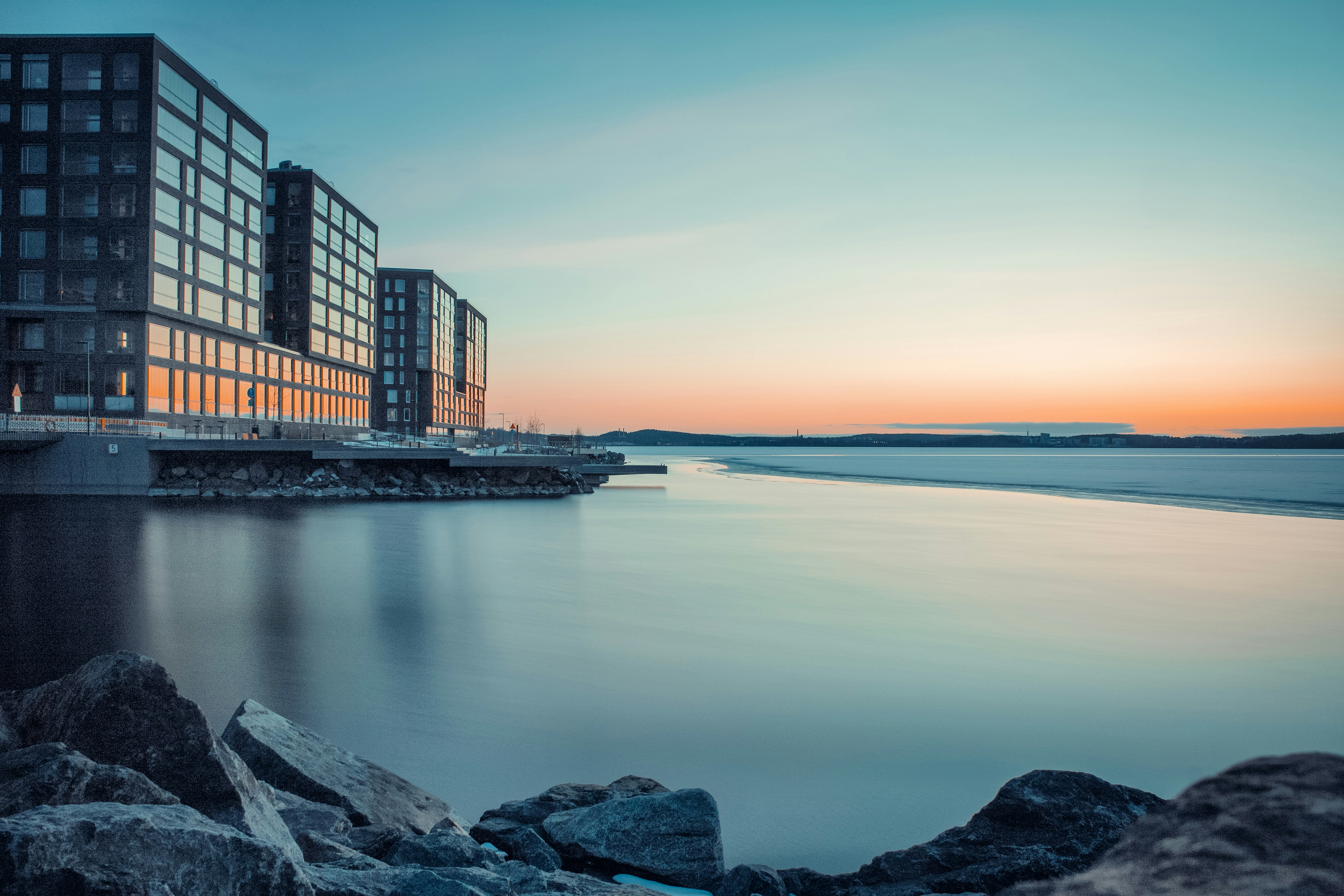 Ranta-Tampella long exposure. Tampere, Finland. | Modern buildings by calm water at sunset