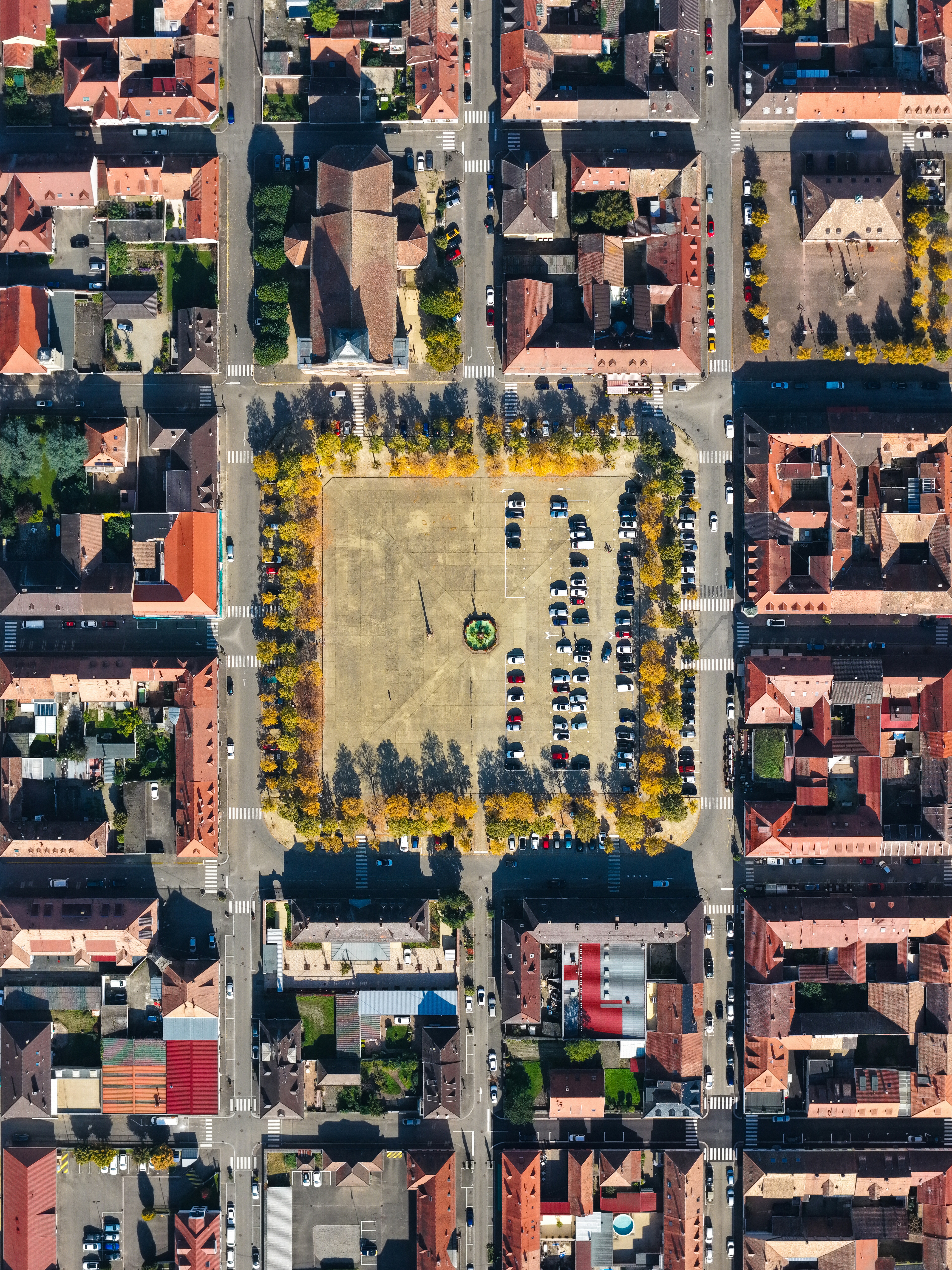 Aerial view of a town square with surrounding buildings.