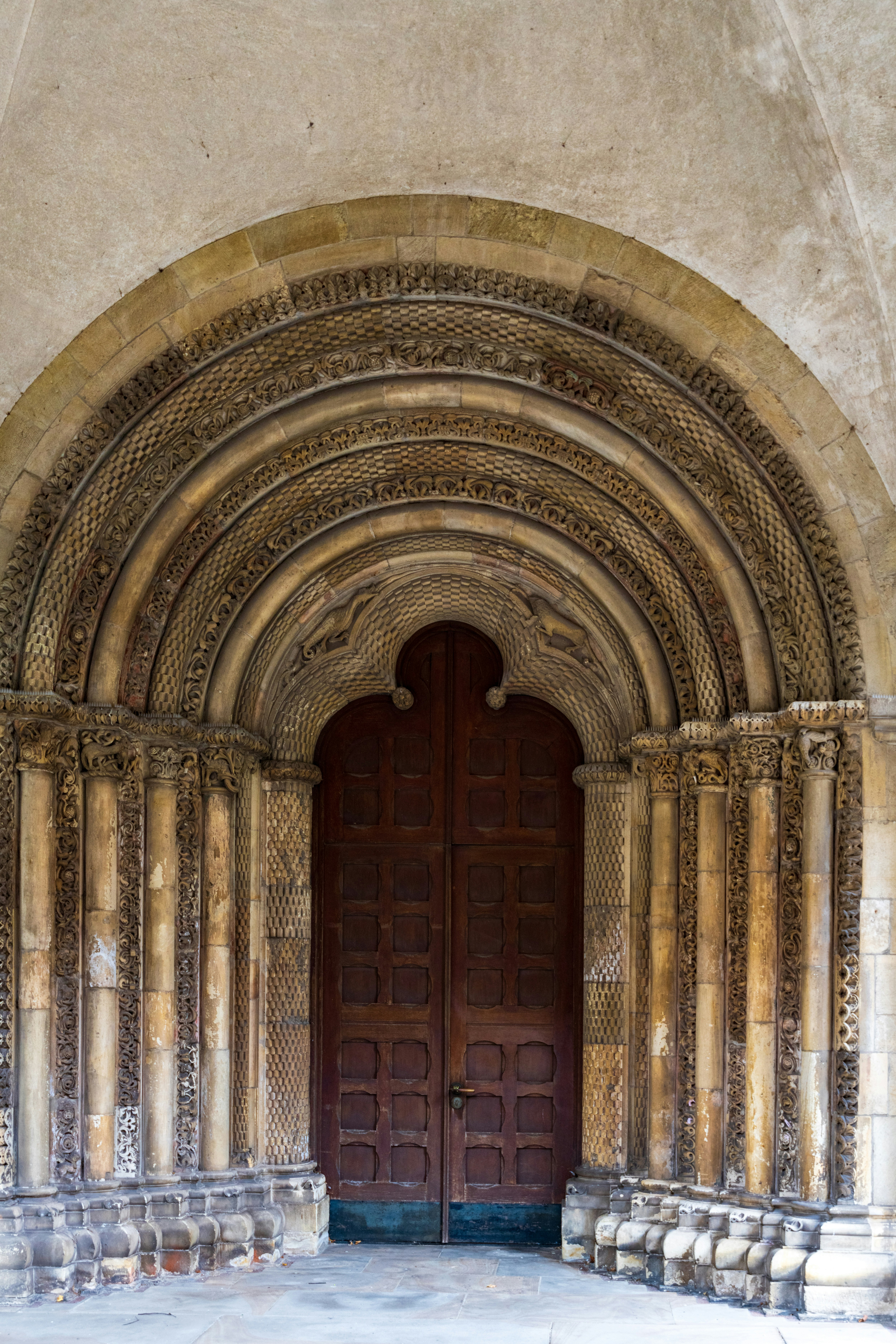 Ornate stone archway with large wooden doors