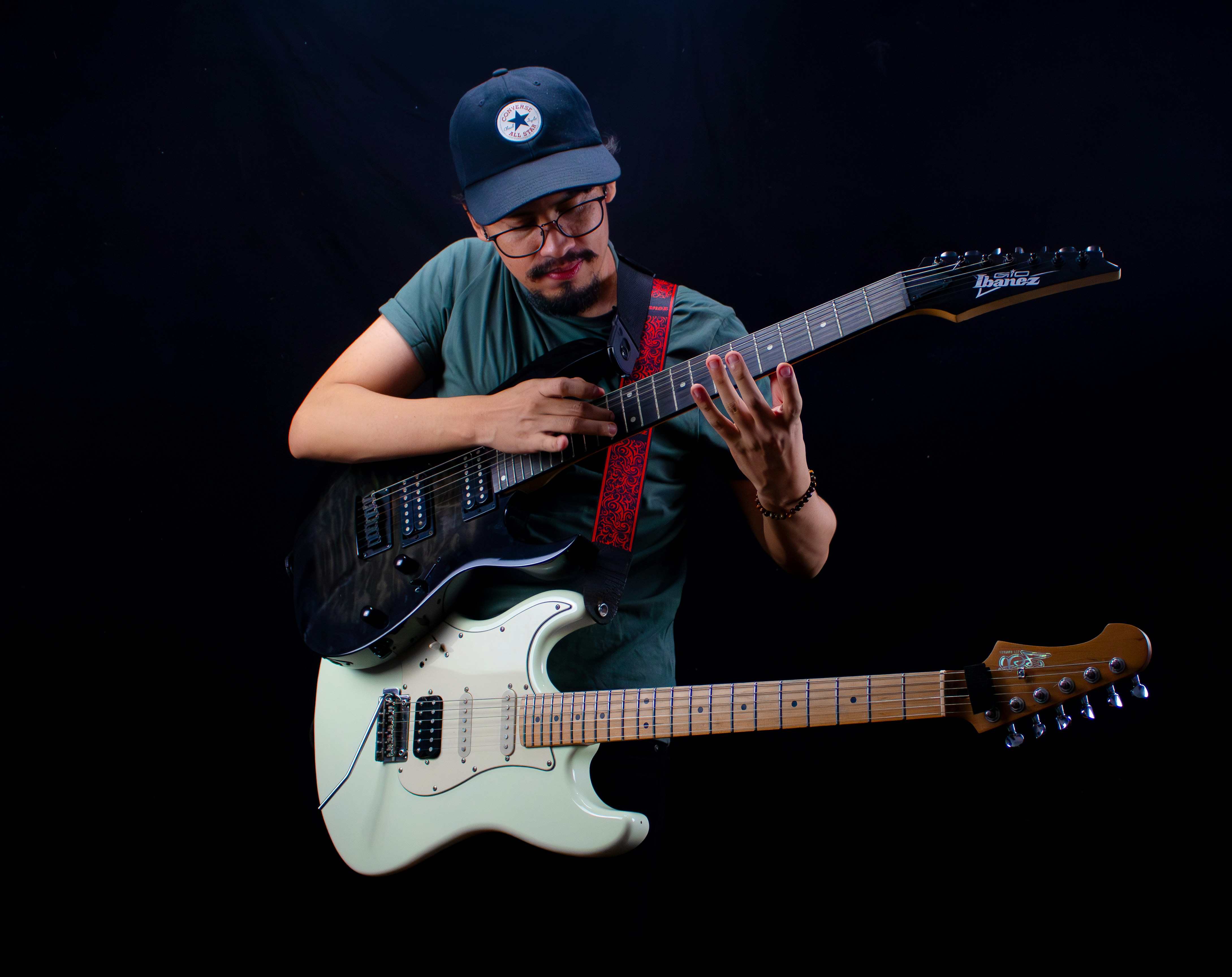 Man playing two guitars against black background photo – Free Art Image ...