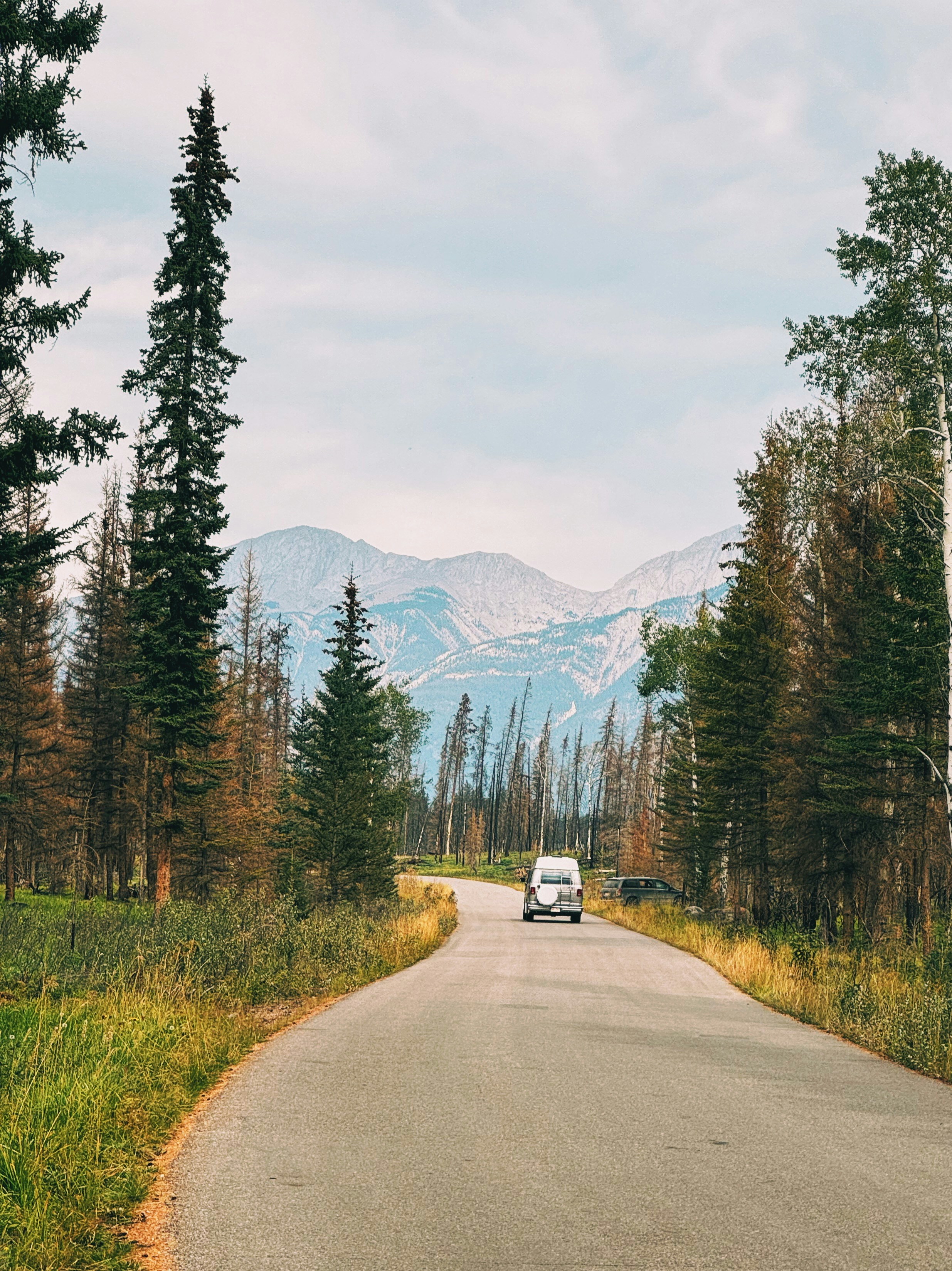 Van driving on a road towards mountains