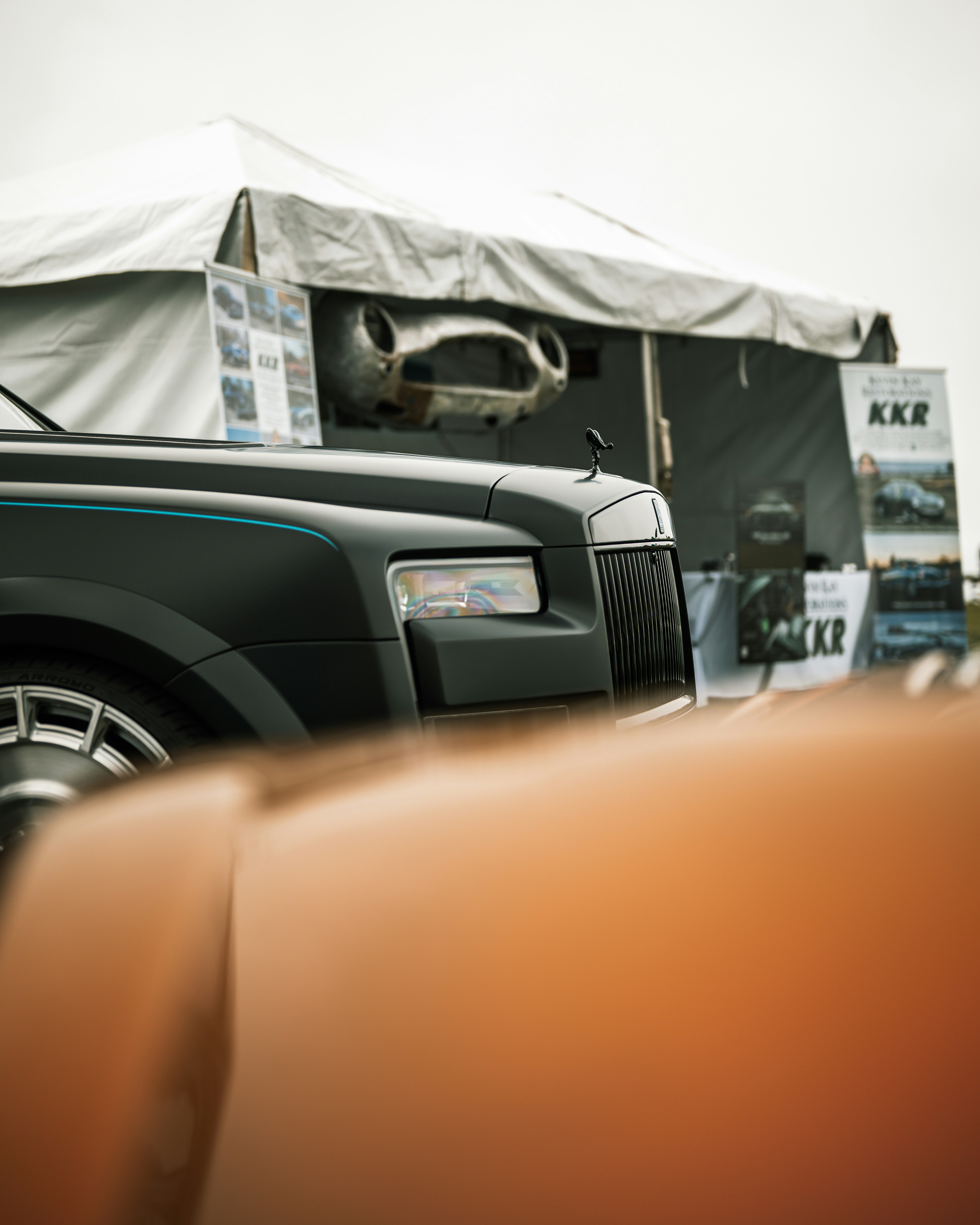 Turquoise Pinstripes Guard a Matte-Black SUV at the Auto Show Canopy