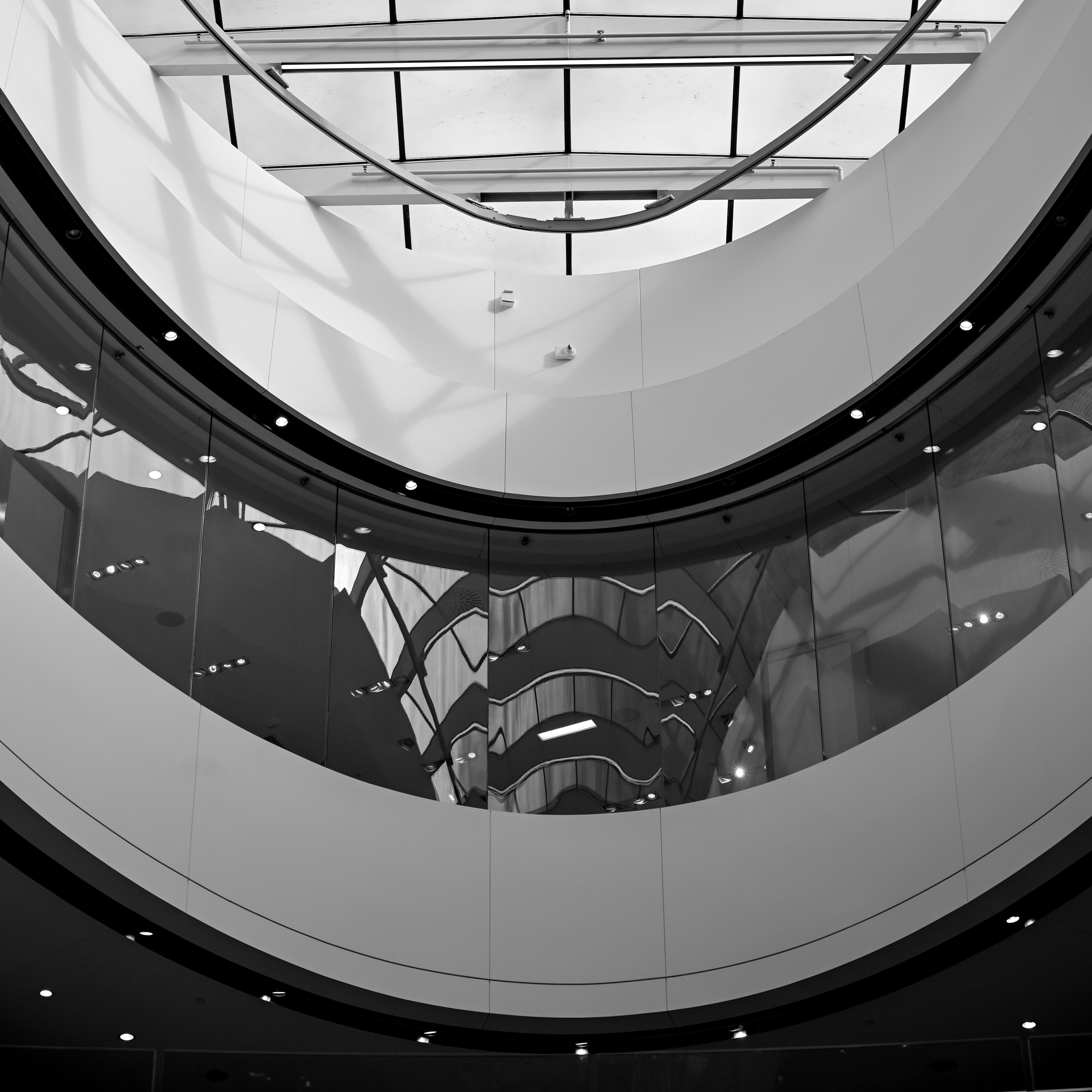 Modern building interior with curved balconies and reflections