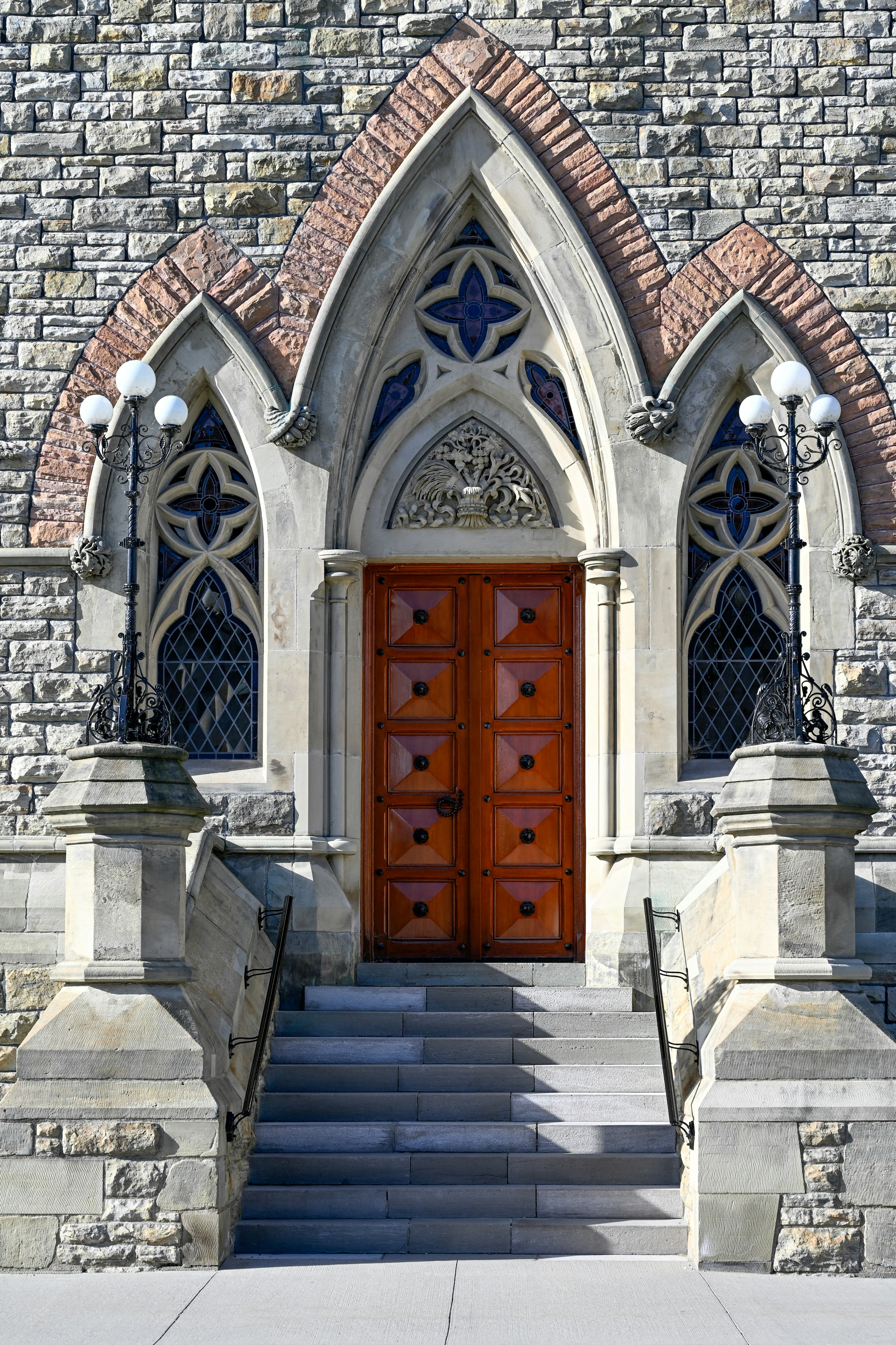 Ornate wooden doors with stone steps leading up.