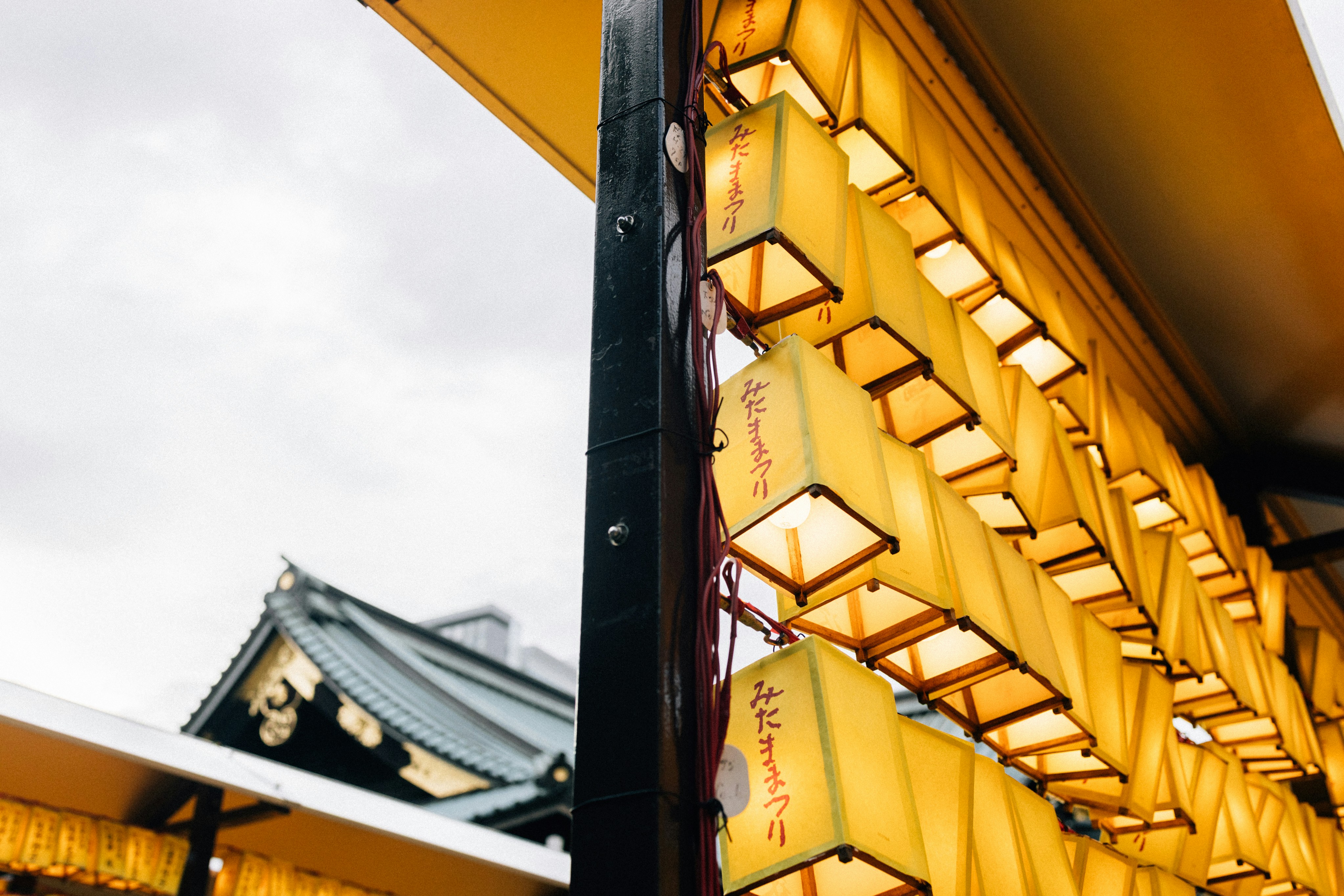 Row of yellow lanterns hanging outdoors photo – Free Celebration Image ...