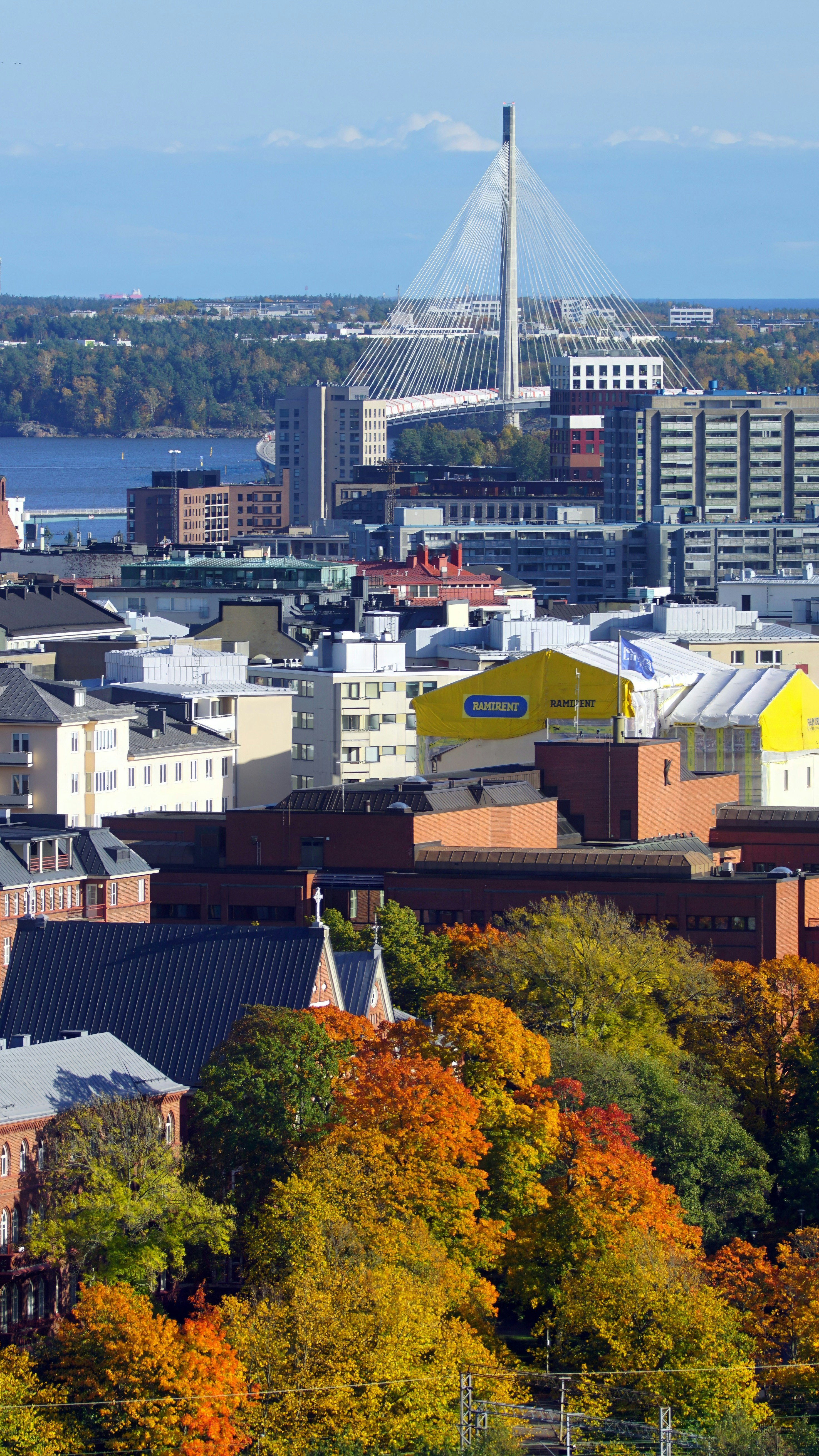 Autumn colors and a brand new bridge in Helsinki, Finland. | Cityscape with autumn trees and modern bridge
