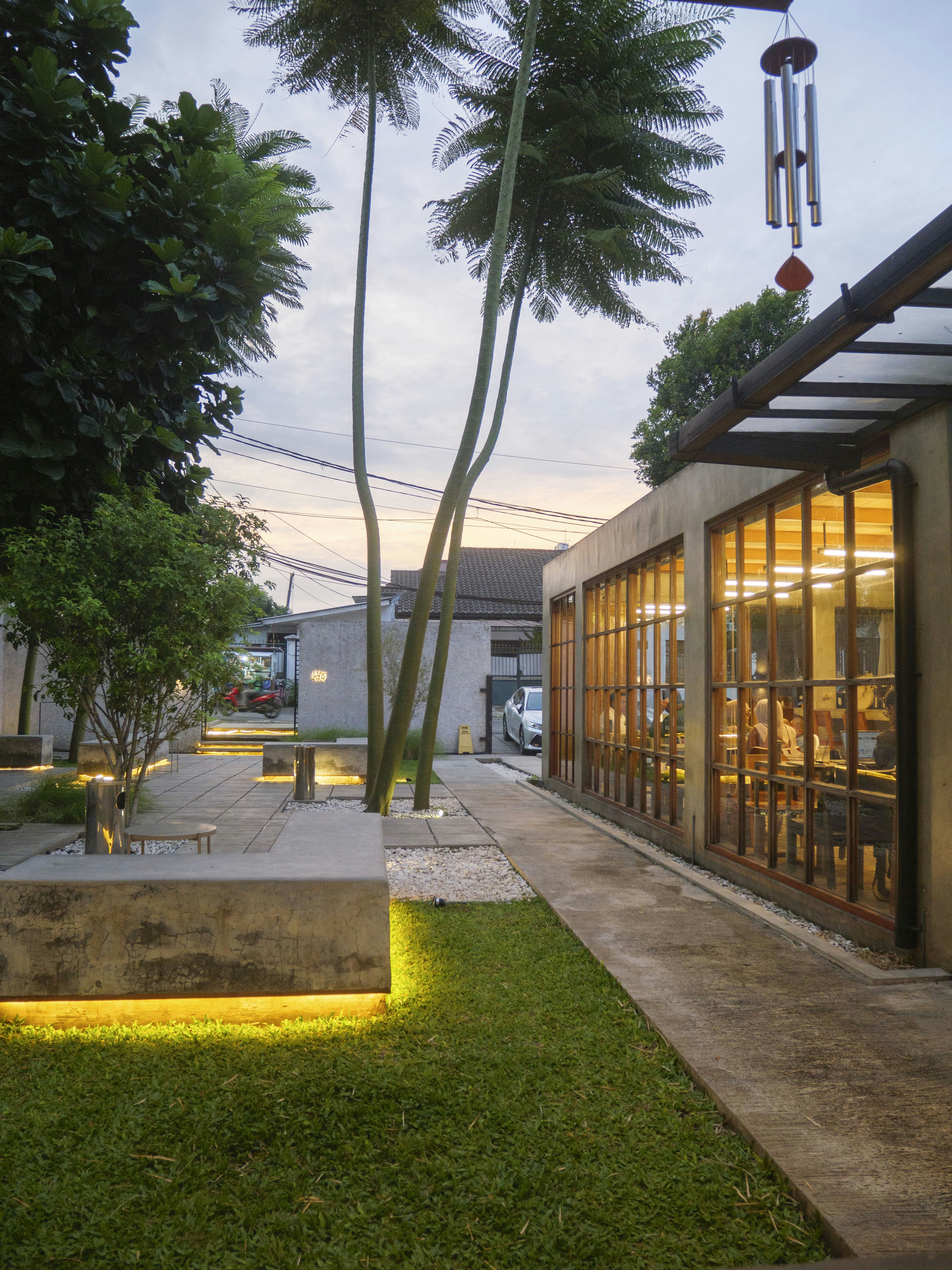 Modern building with outdoor seating area at dusk