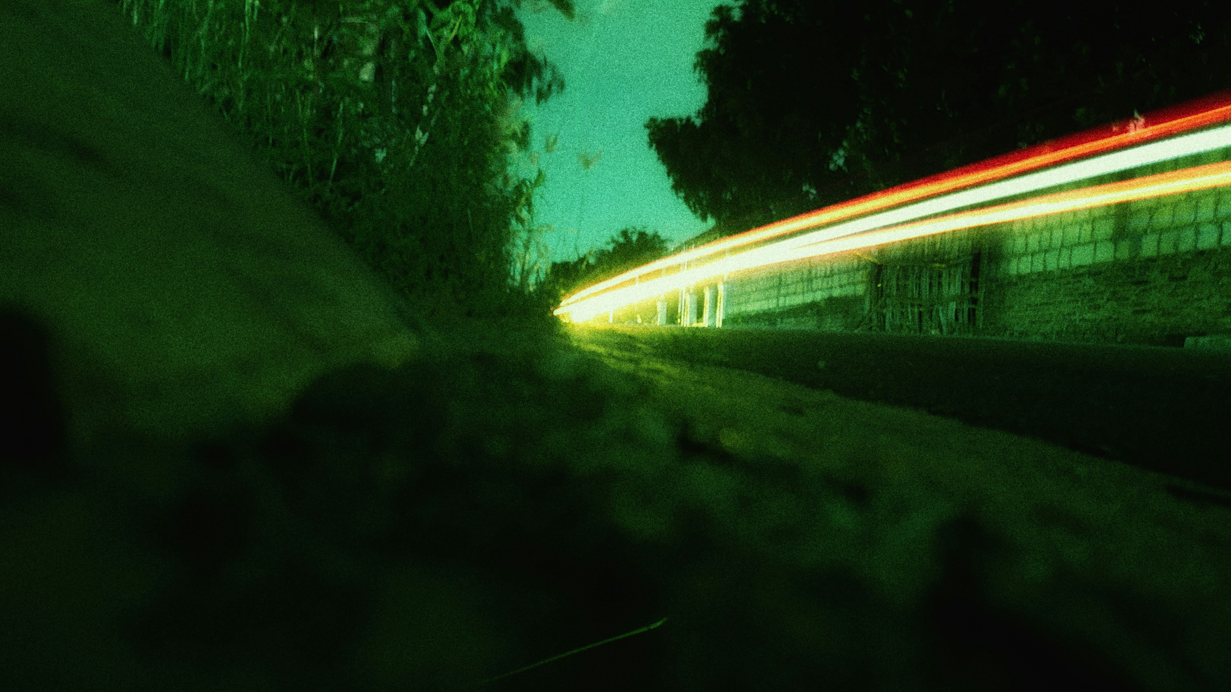 Streaks of light on a dark road at night