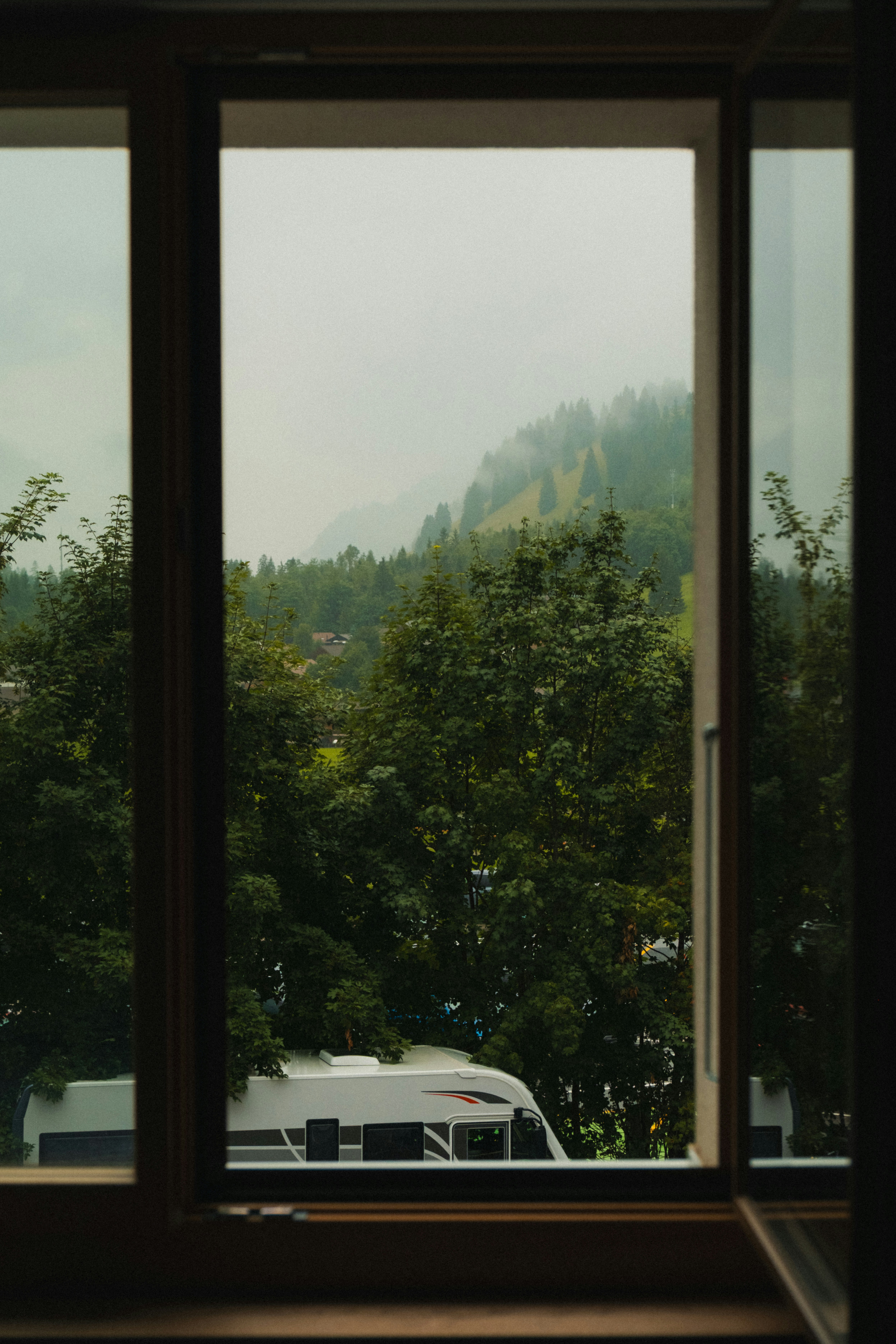 View of misty mountains through a window