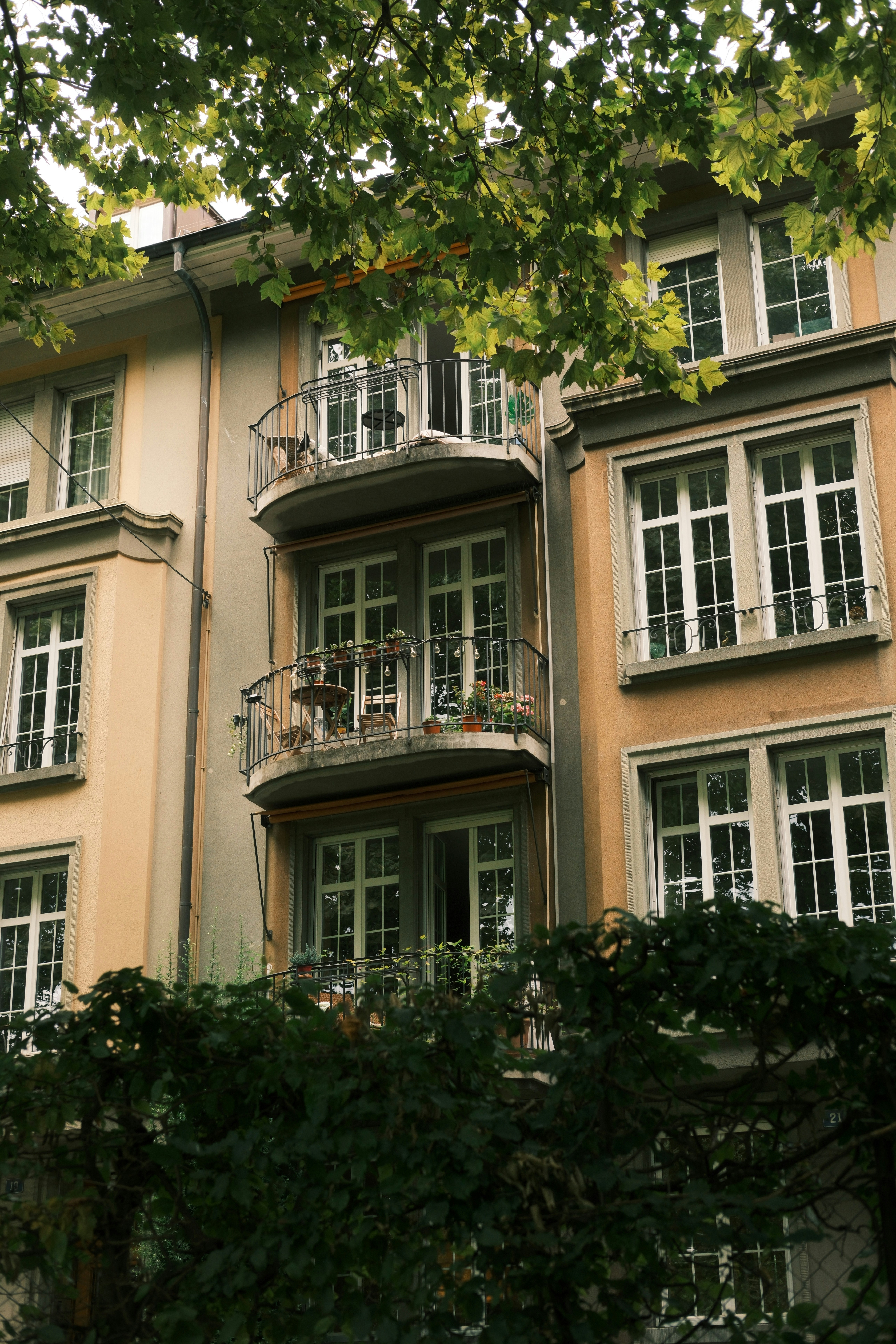 Apartment building with balconies and trees