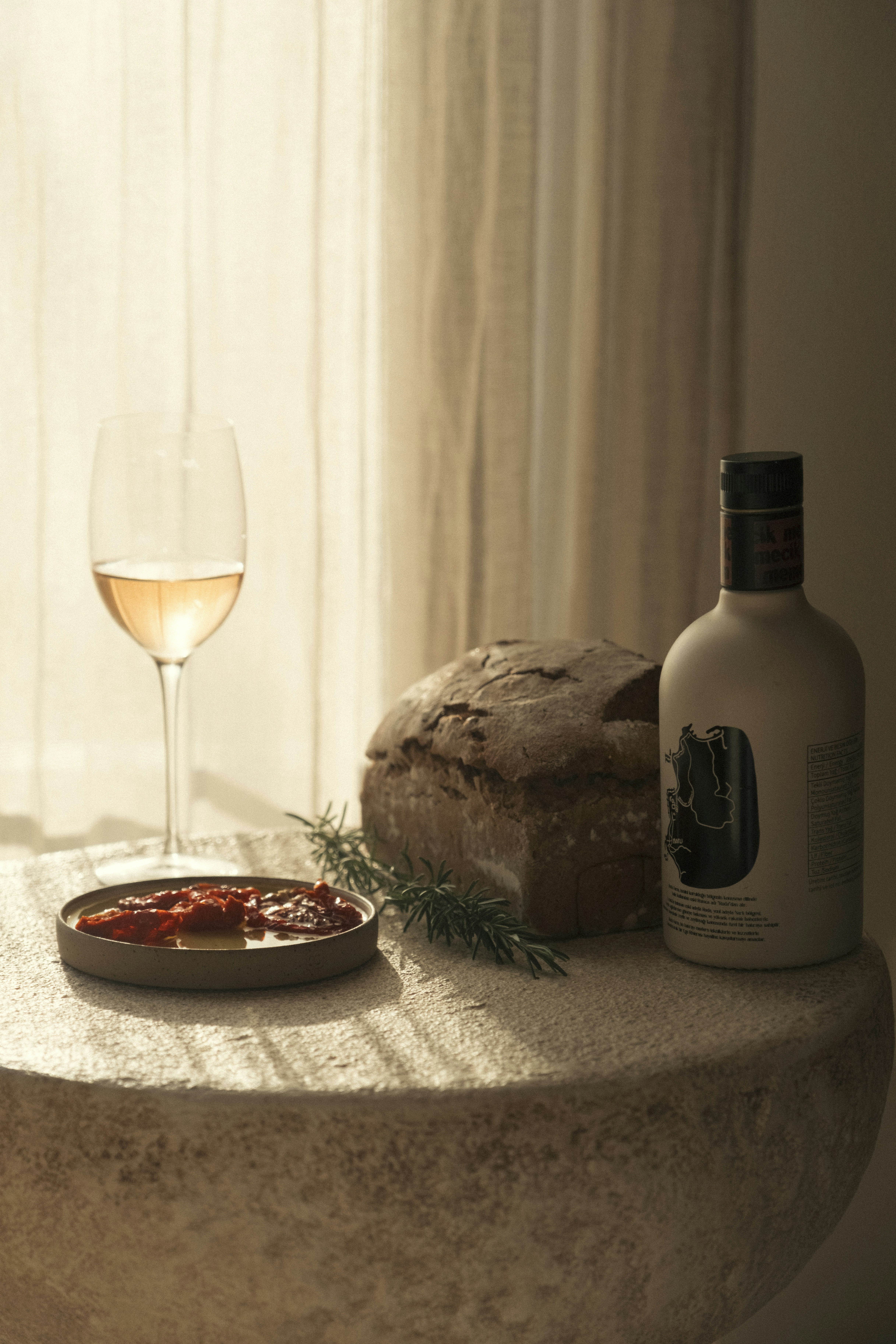 Rosé in the Round: A Rustic Still Life of Bread, Bottle, and Sauce