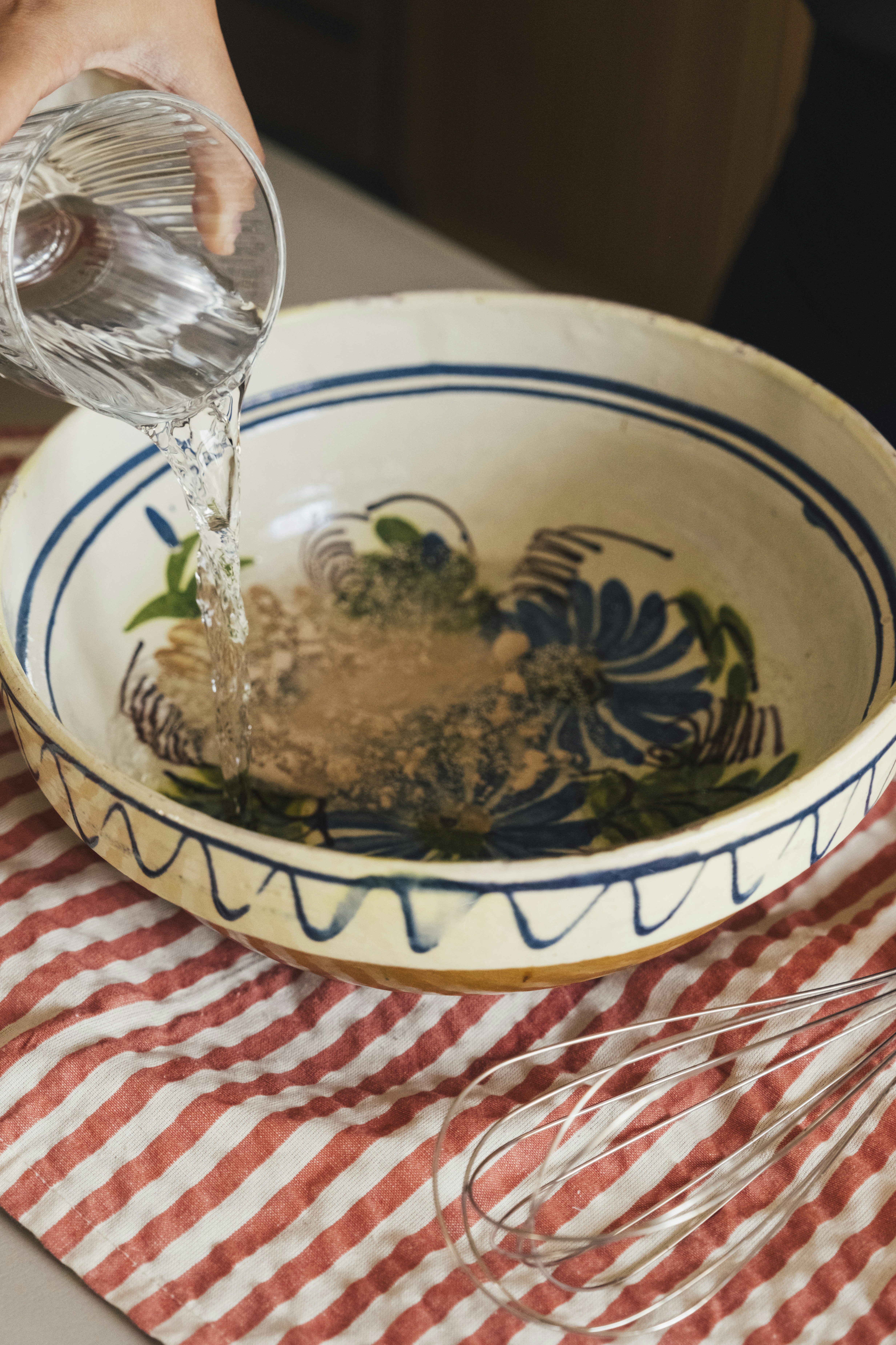 Cascading Clarity: Pour into a Floral Blue Ceramic Bowl