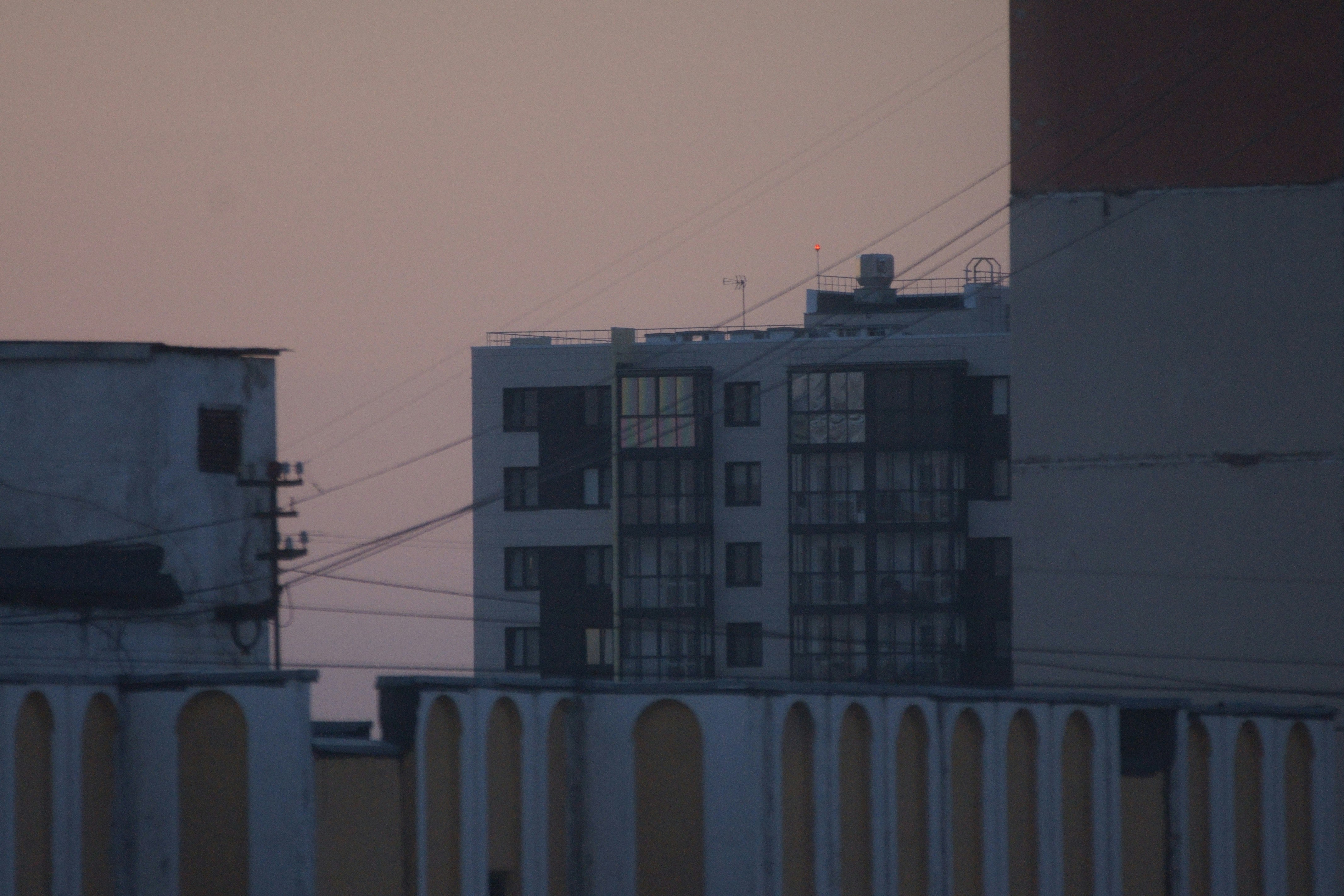 Apartment buildings against a soft twilight sky
