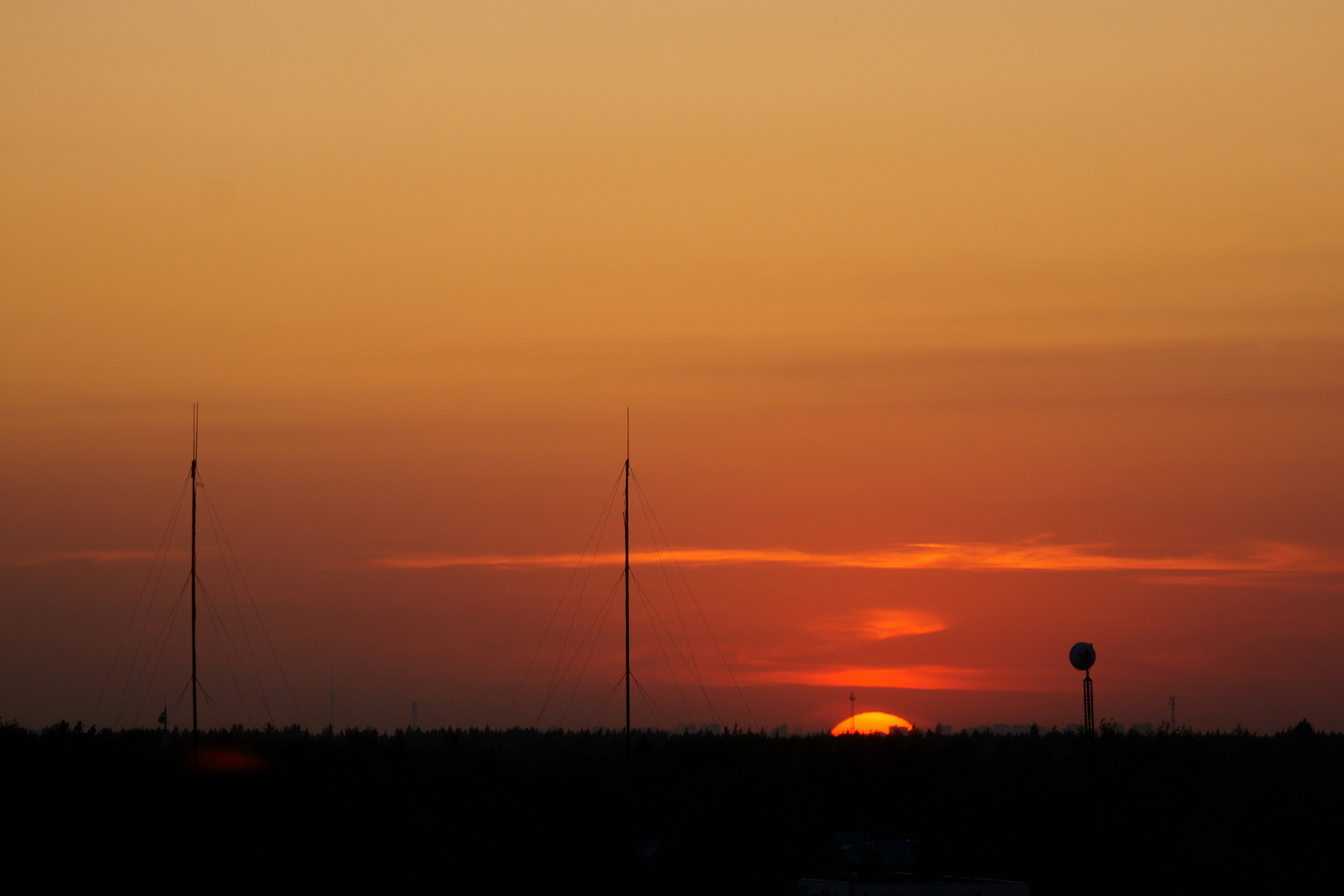 Sunset over the horizon with radio towers.