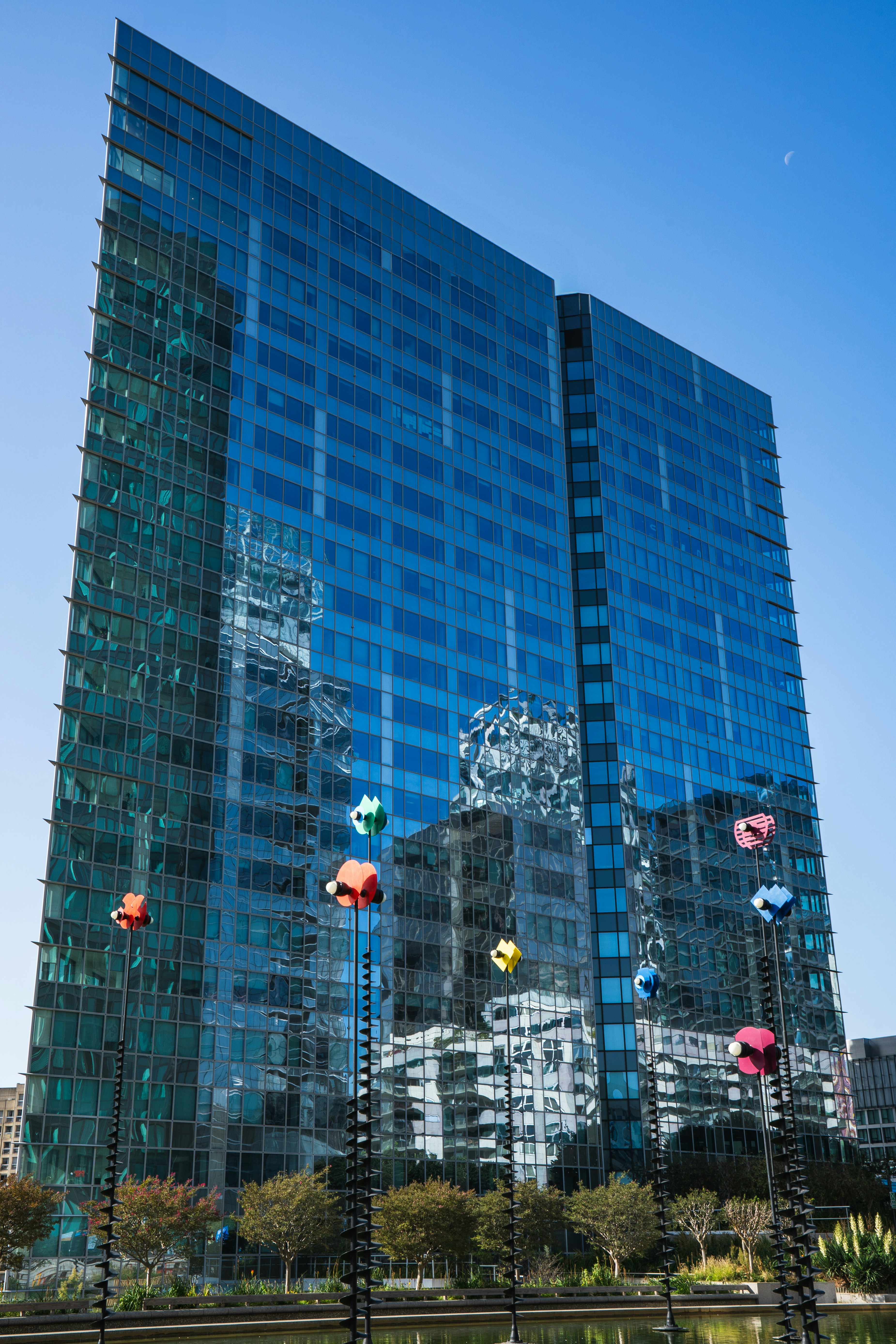 Azure Glass Tower: a Mirror of Sky, Framed by Floating Color Orbs