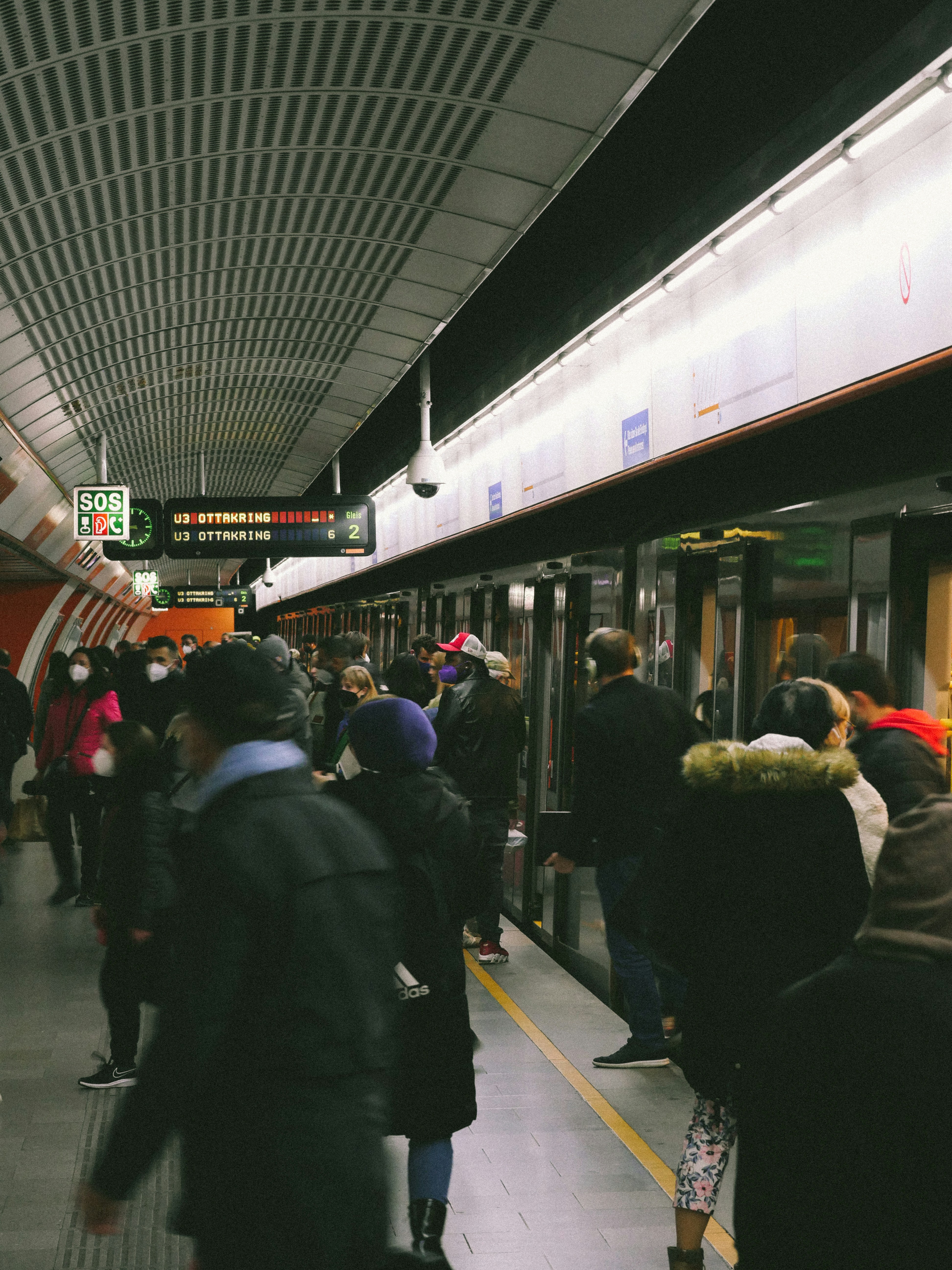 People waiting for a train on a subway platform.