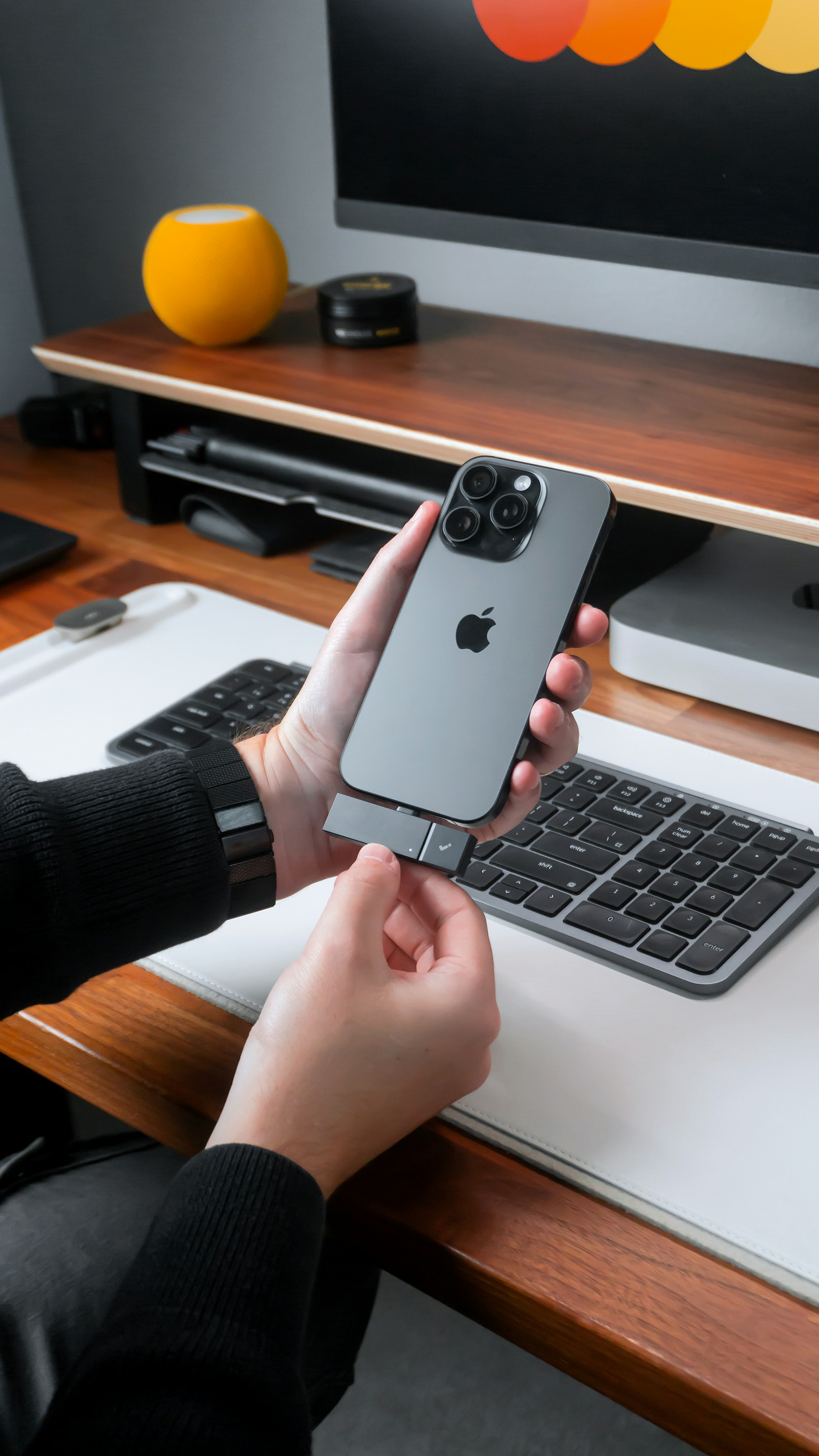 Person attaching accessory to iPhone near keyboard photo – Free ...