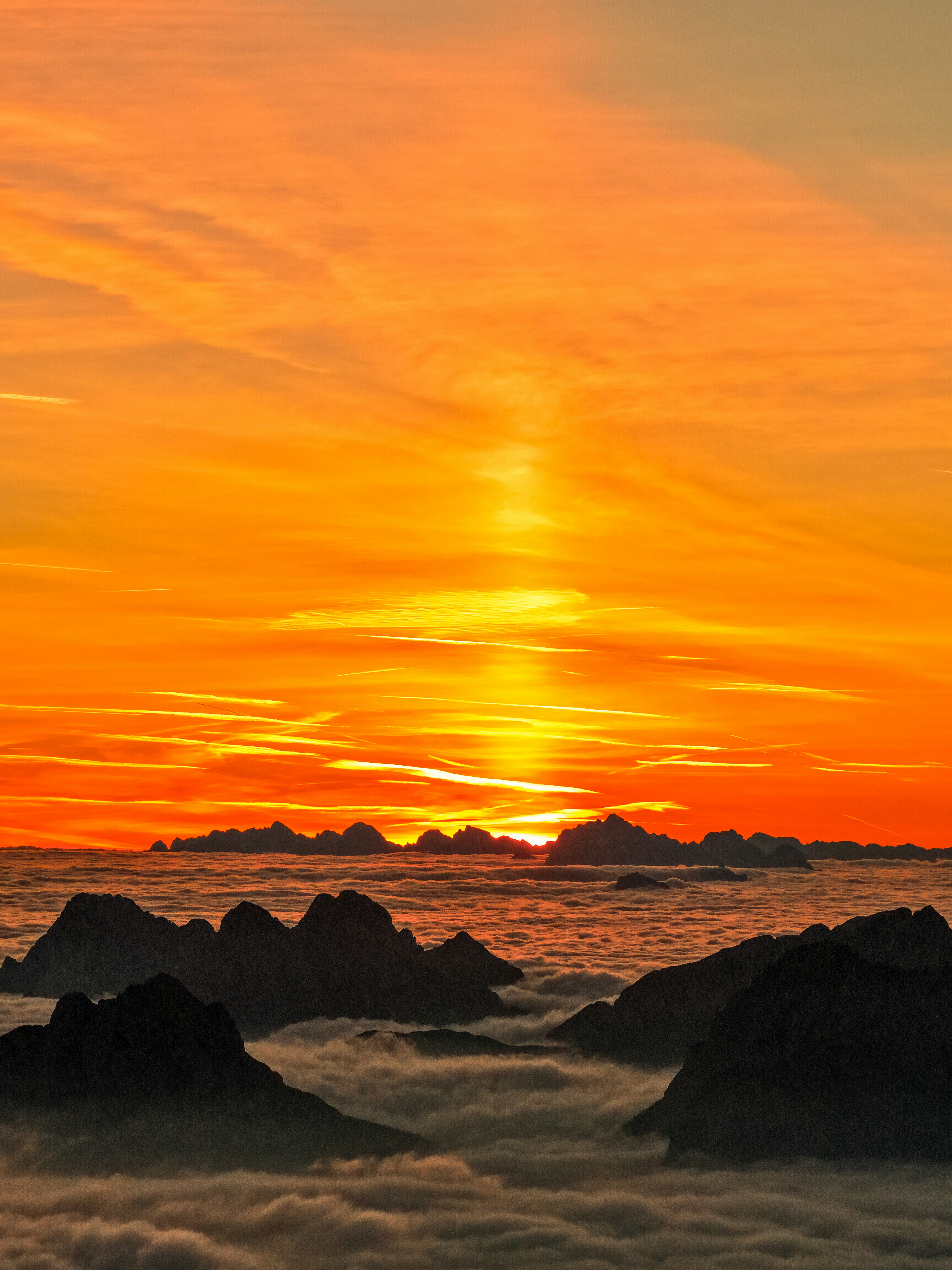 Sunrise over a sea of clouds and mountains