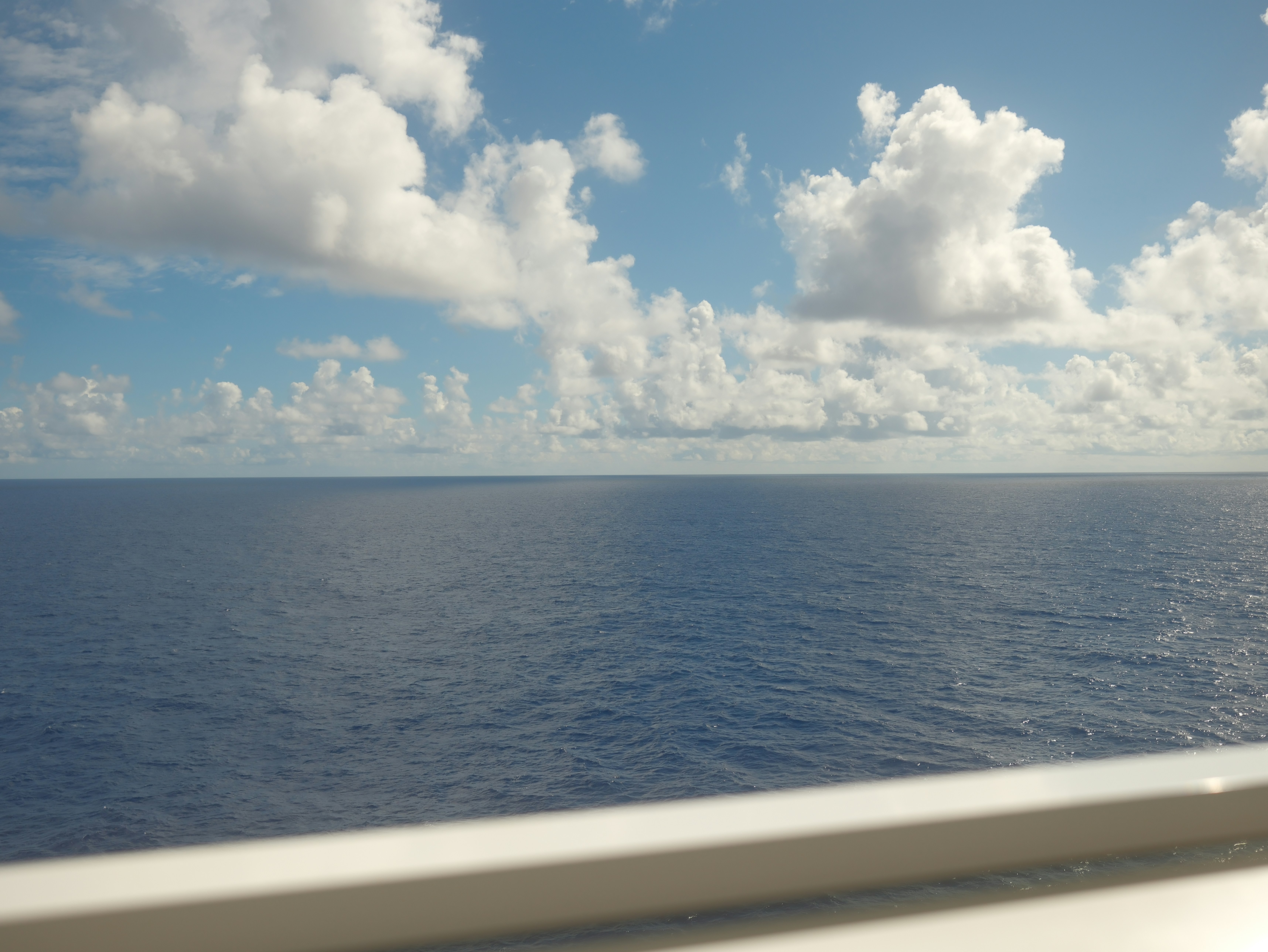 Vast blue ocean under a cloudy sky