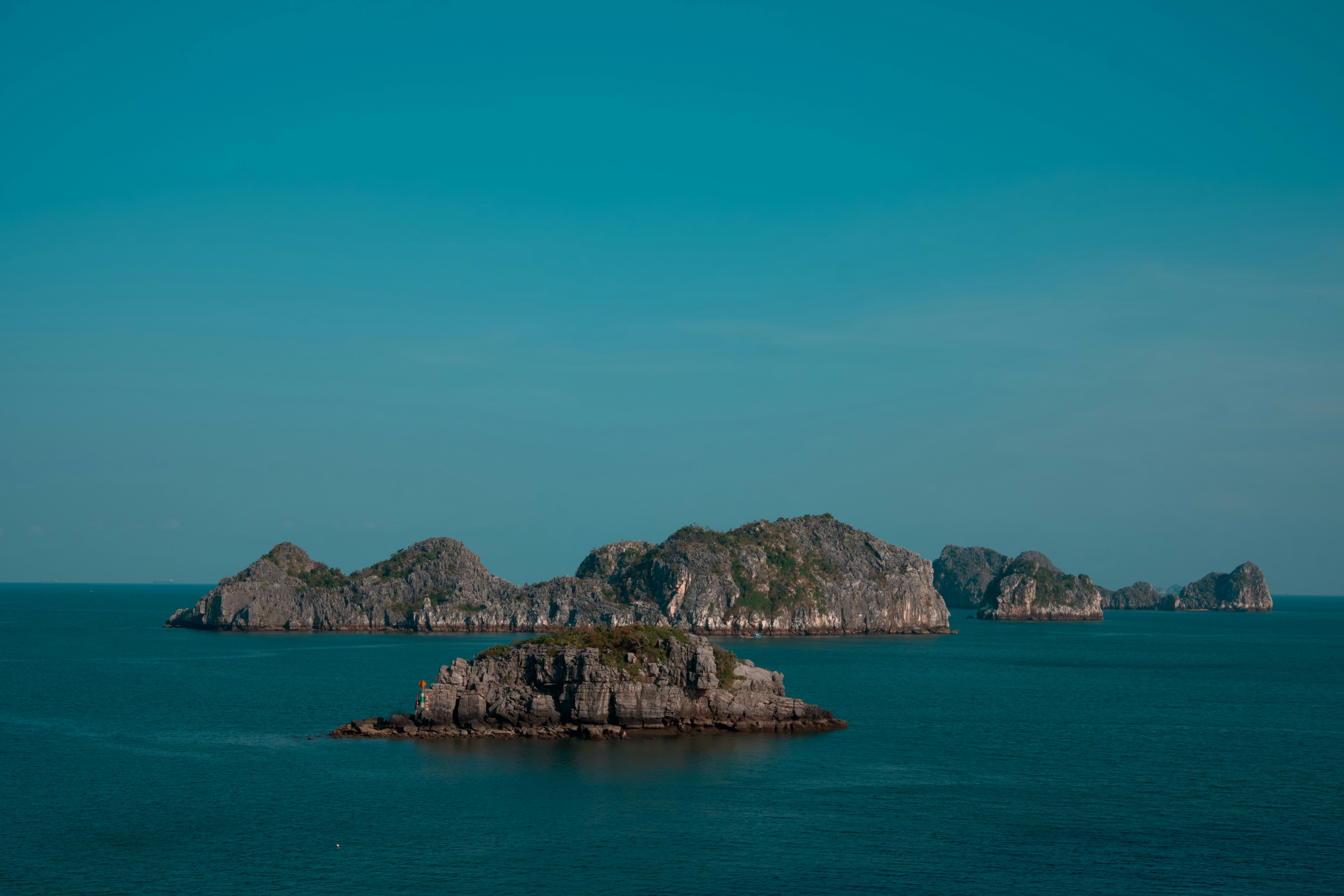 Jagged islands rise from the deep blue ocean.