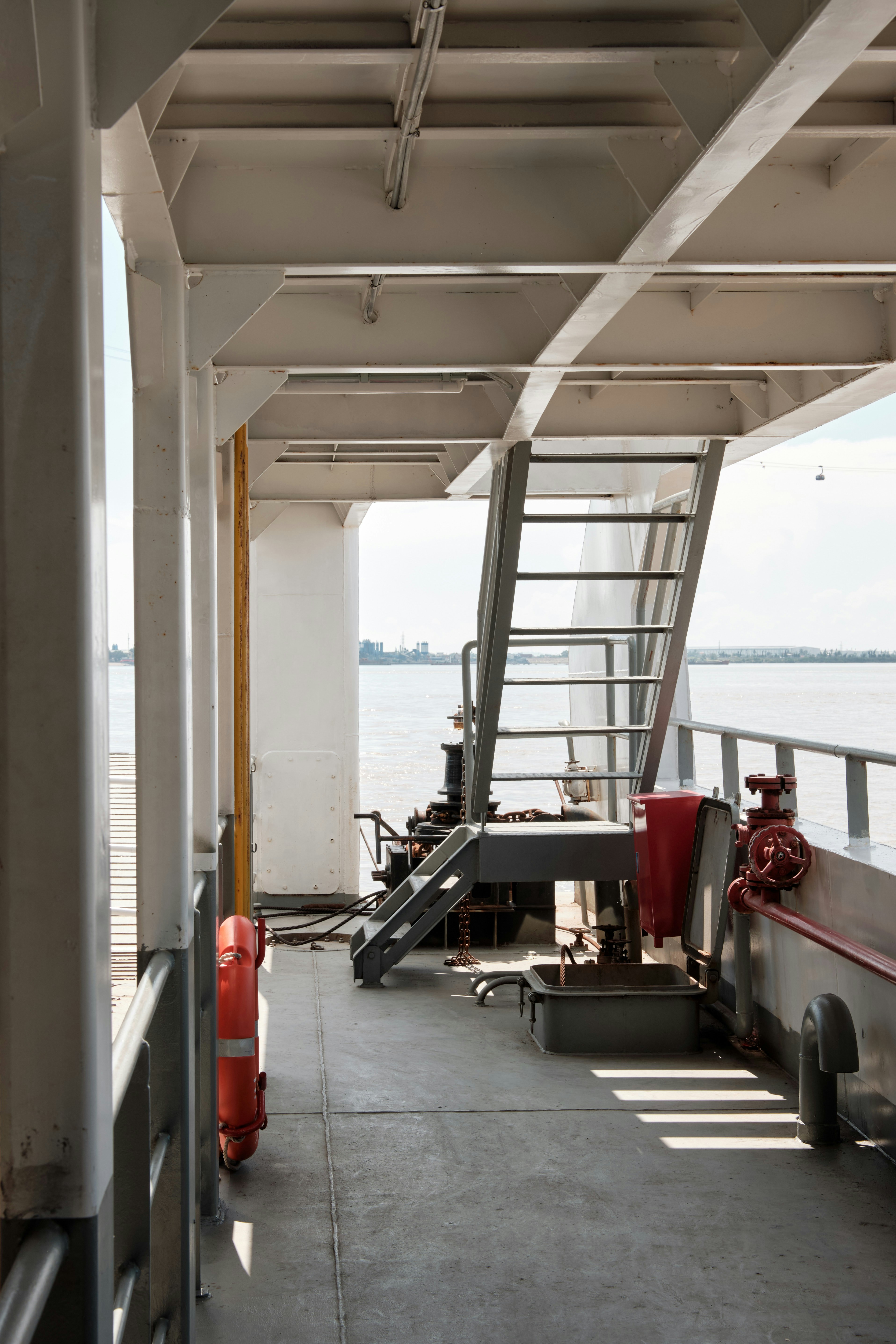 Deck of a ferry with stairs and railing