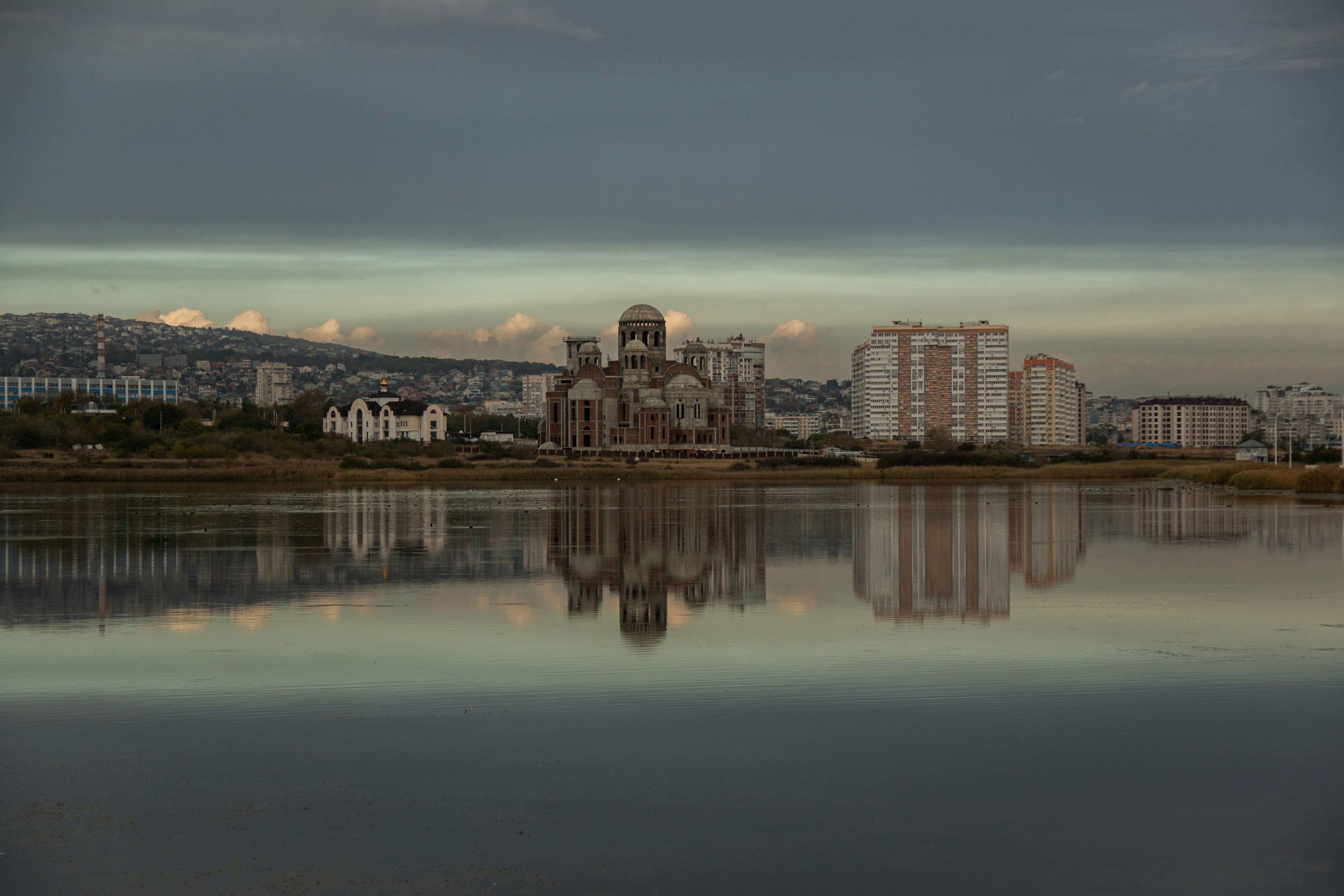 City skyline with a large domed building reflected.