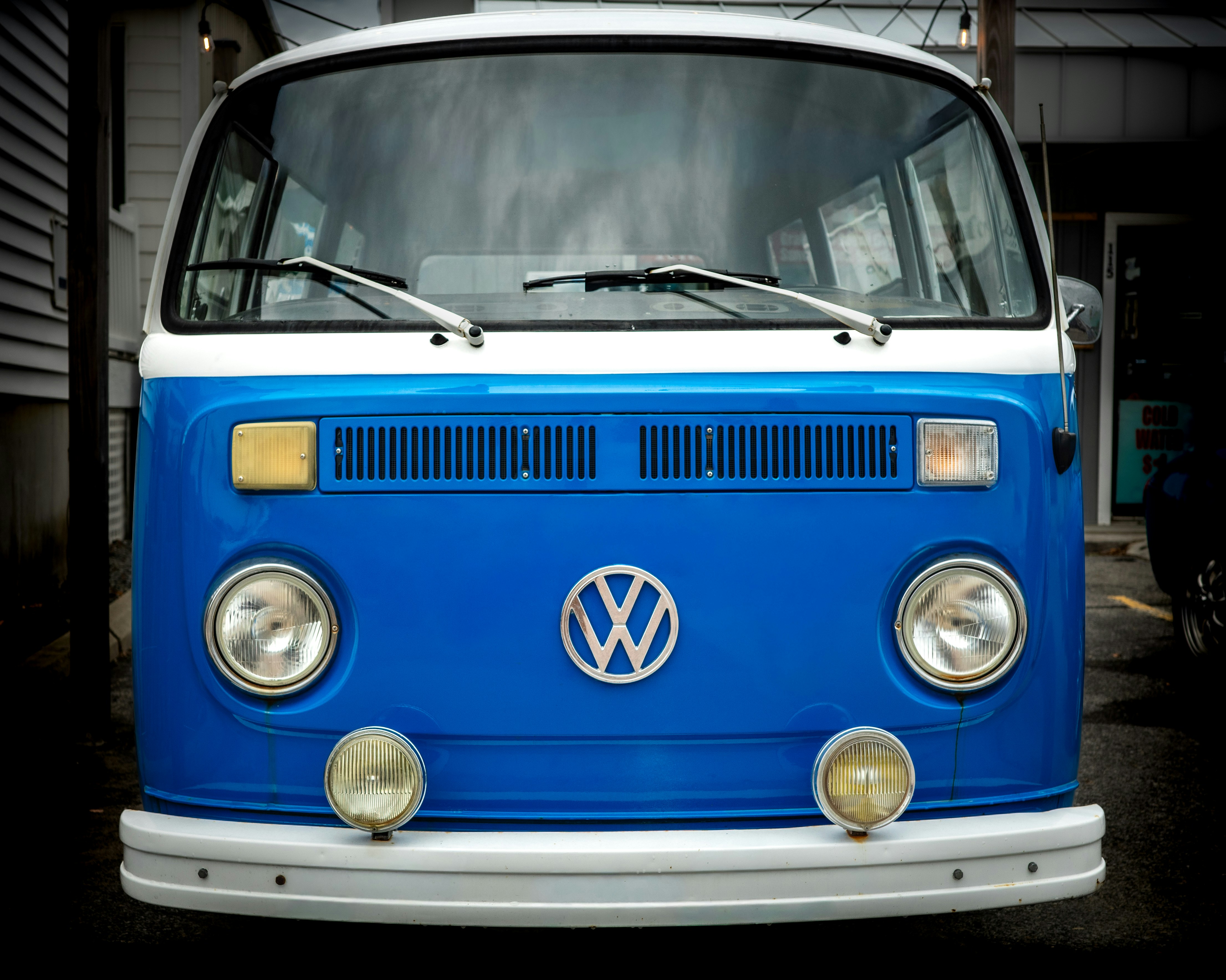 Blue volkswagen van parked outside building