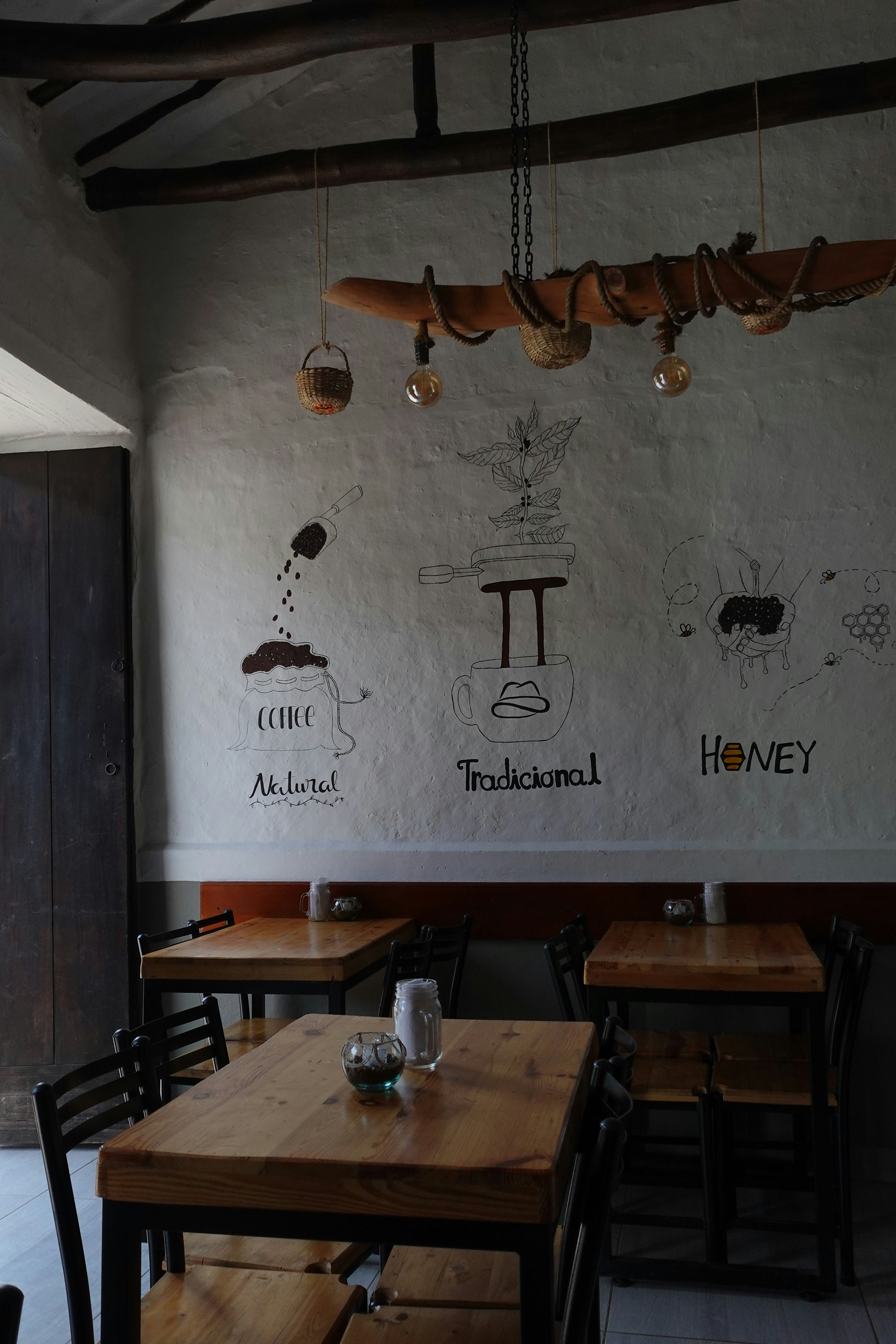 Cozy cafe interior with wooden tables and chairs.