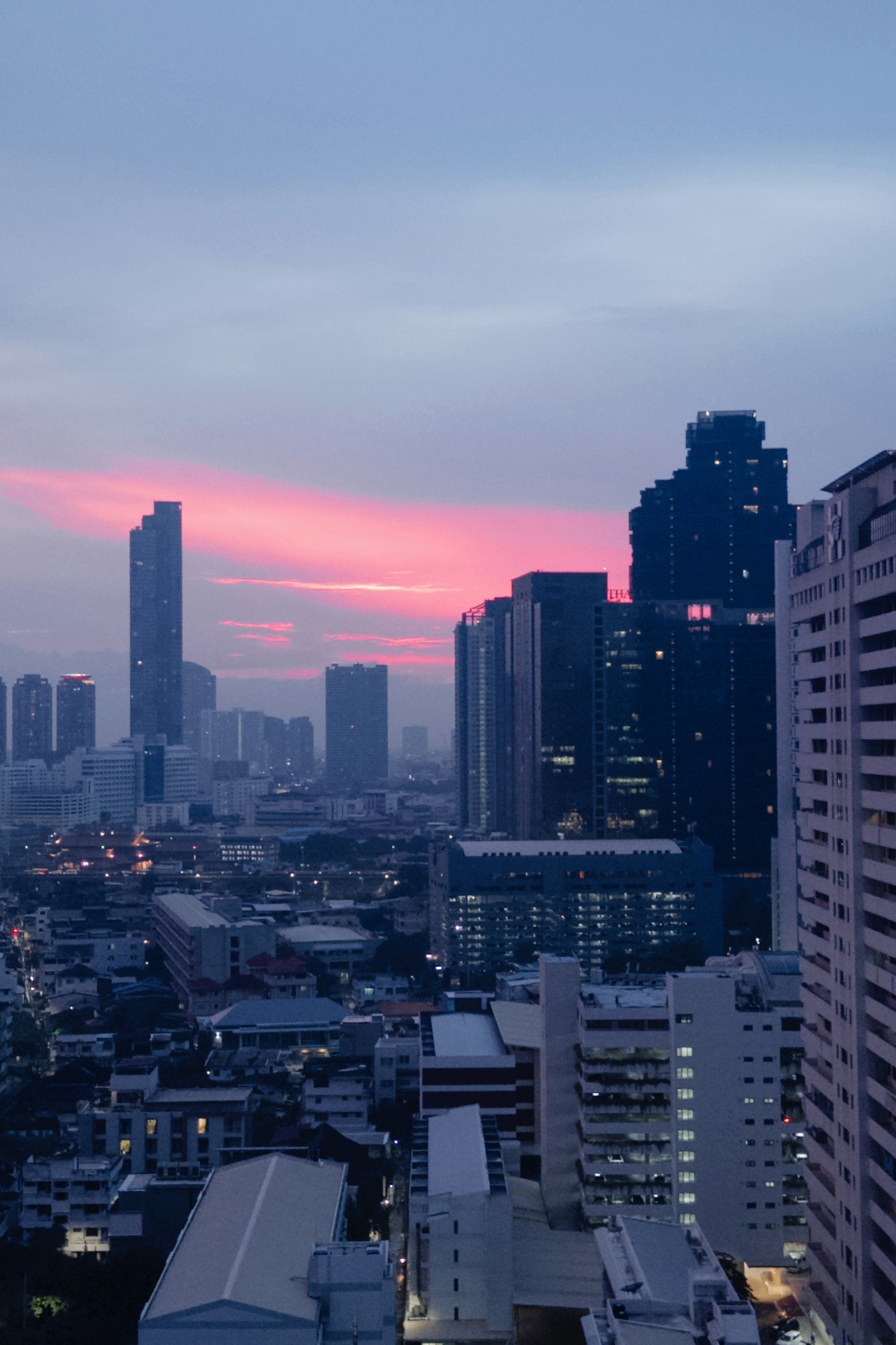 City skyline at dusk with pink clouds