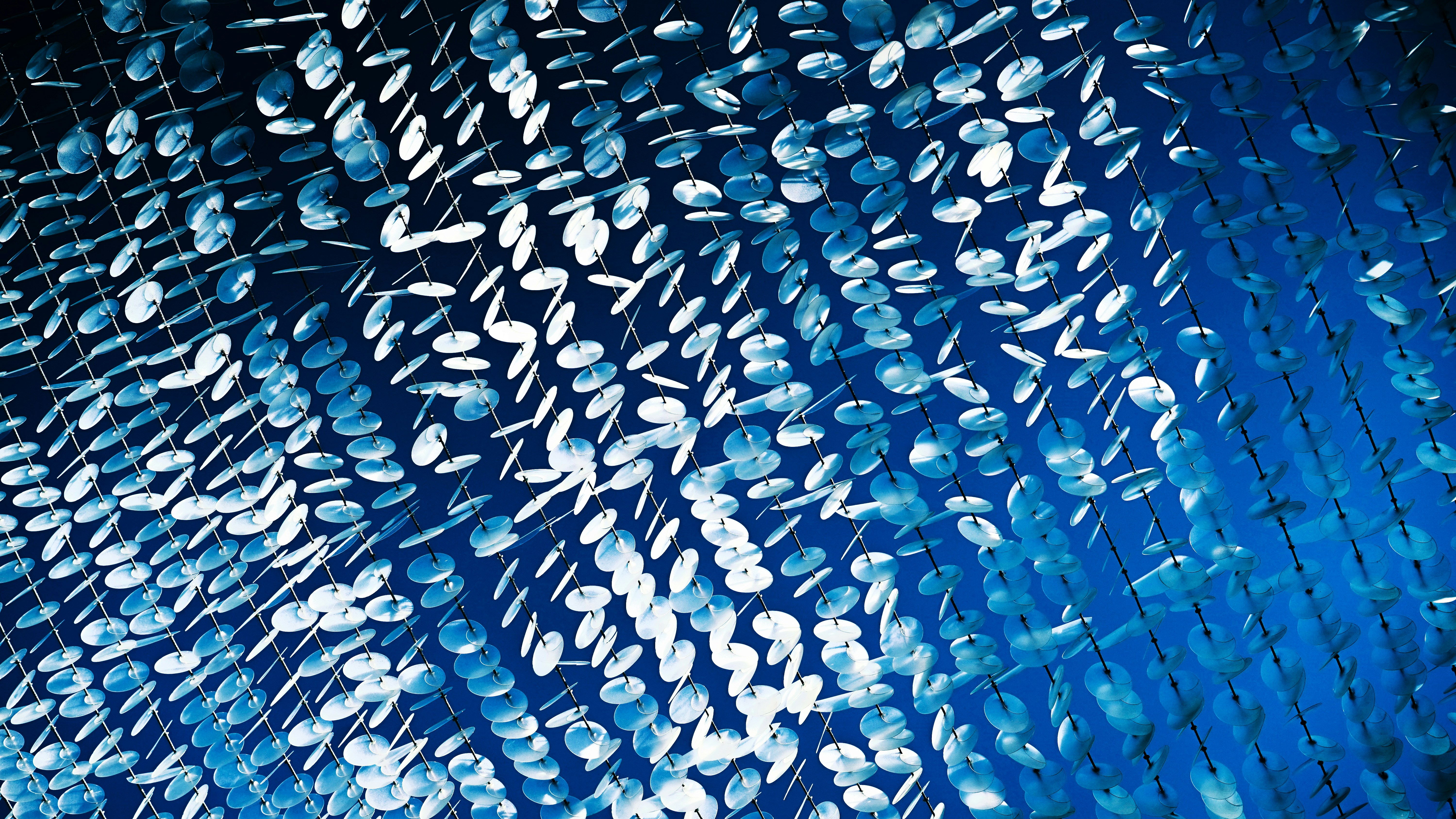 Abstract blue background with hanging circular elements.