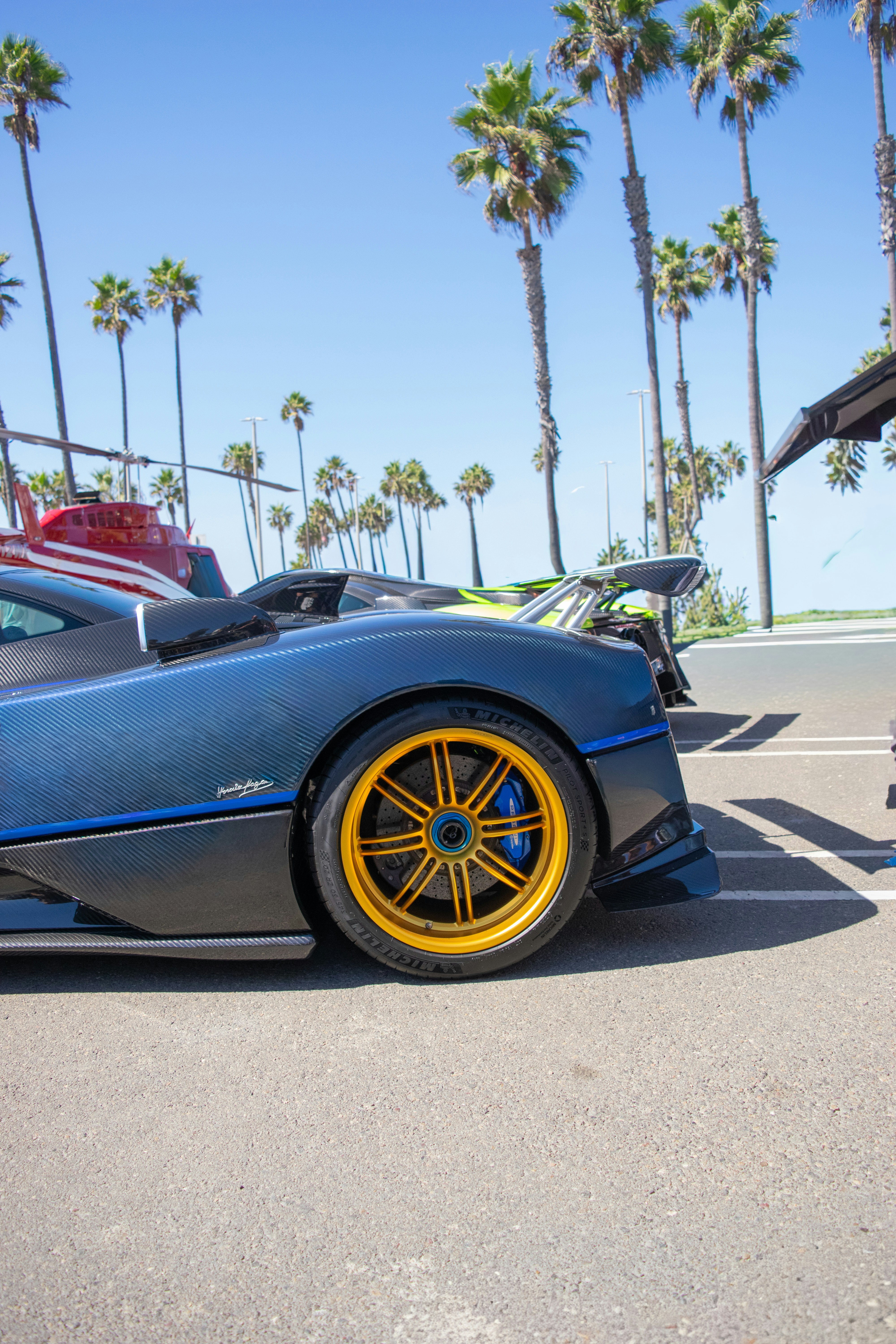 Luxury sports car with gold wheels and palm trees