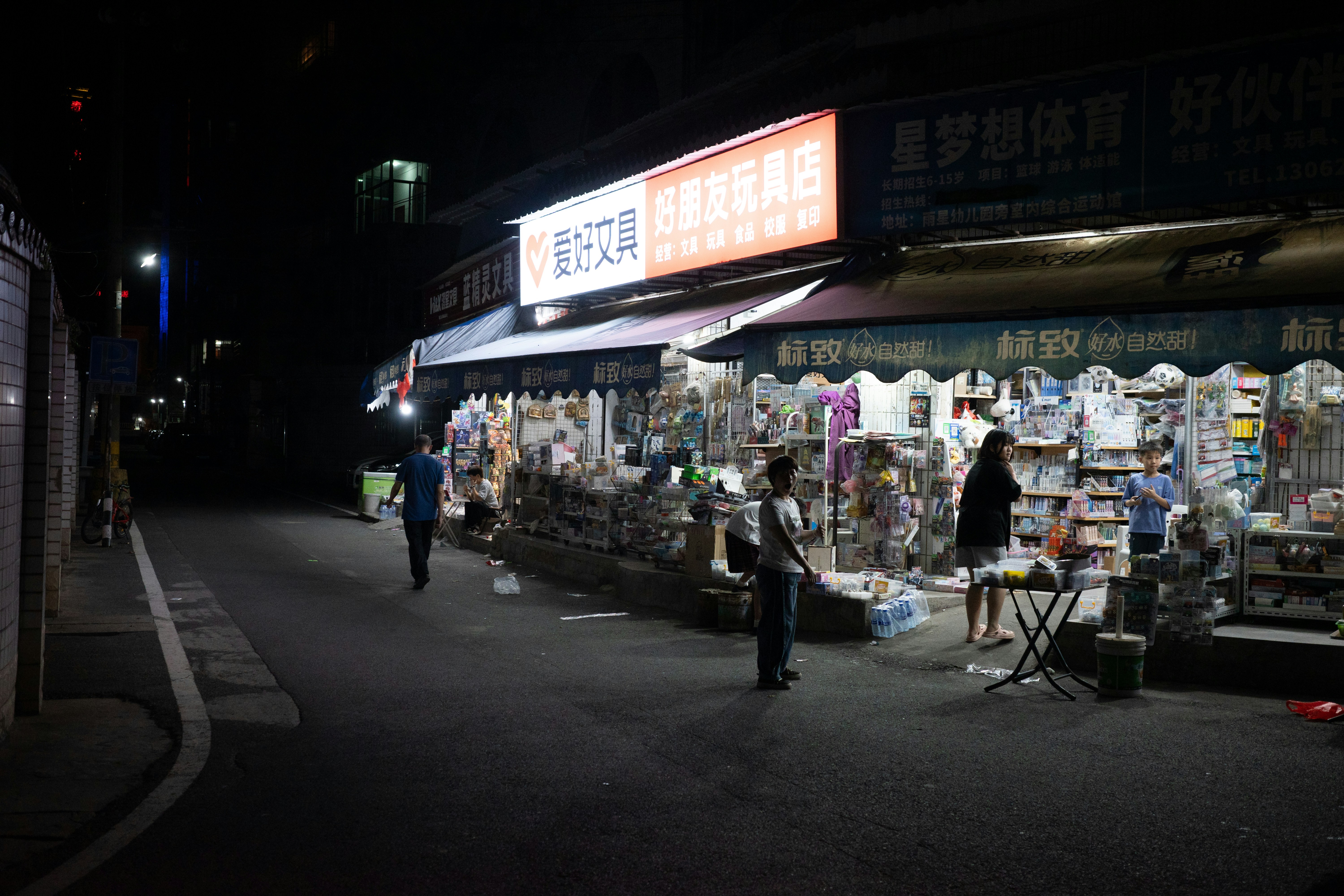 Street scene with shops open at night.