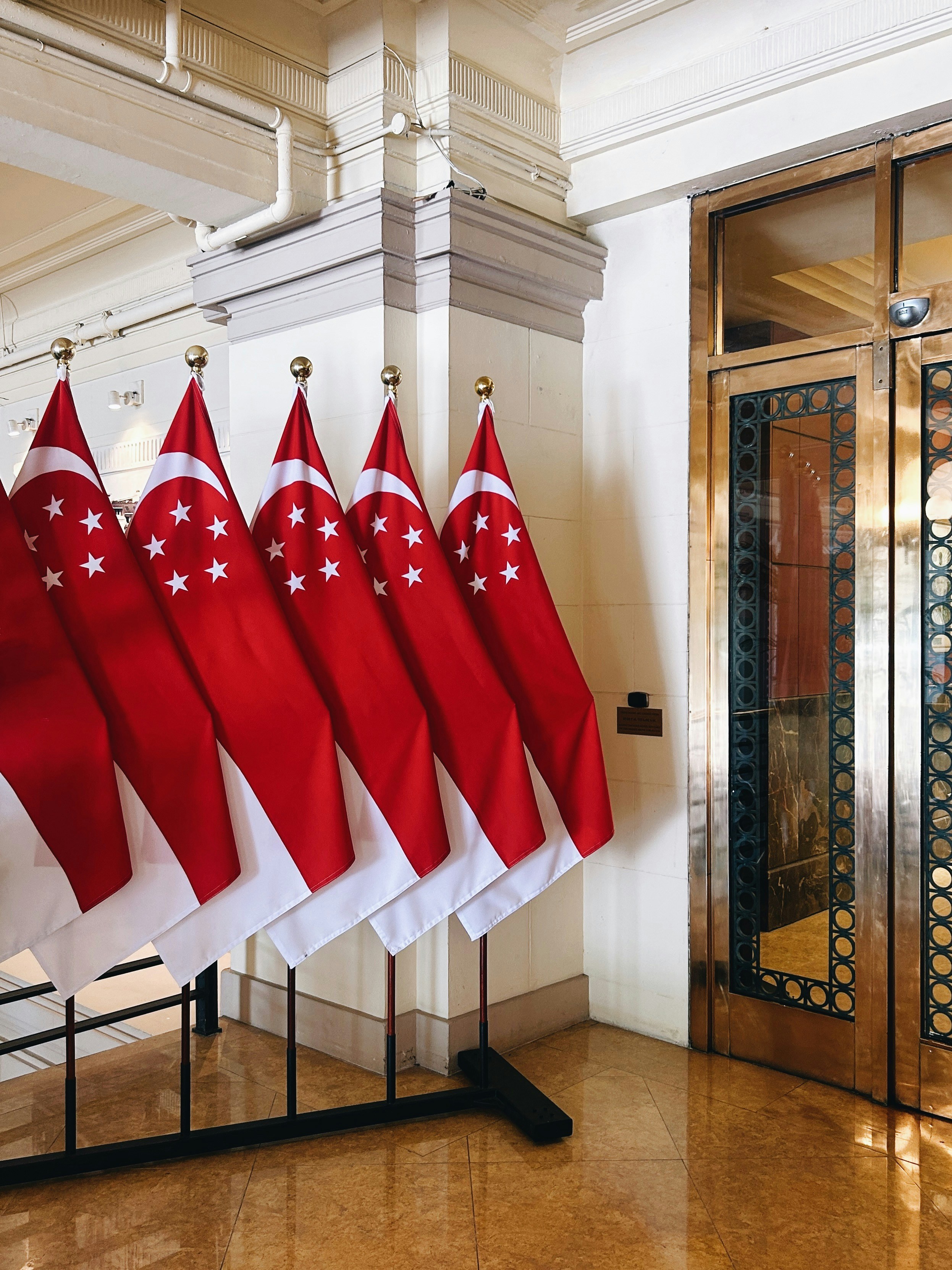 Row of singapore flags displayed indoors