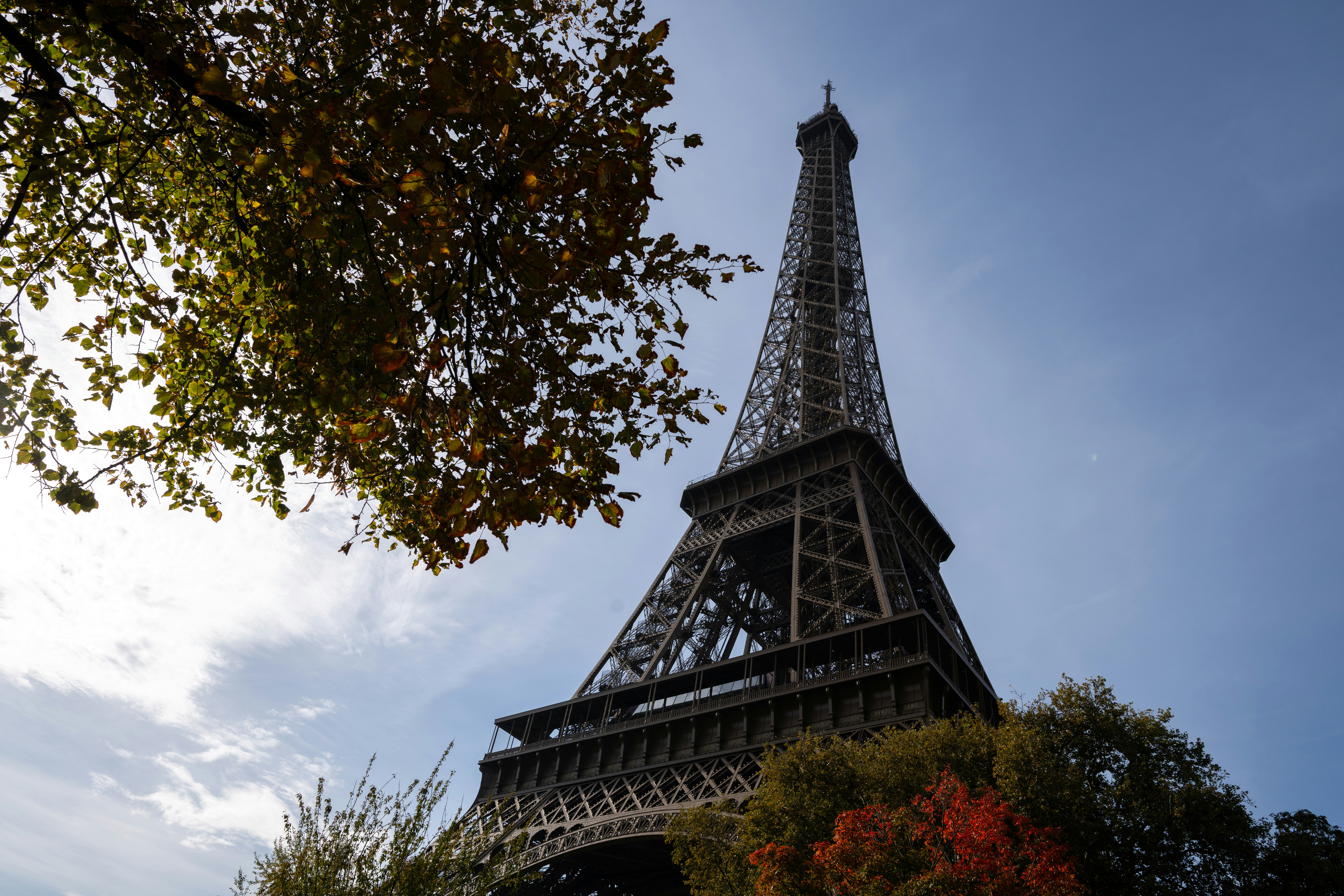 The eiffel tower against a bright blue sky.