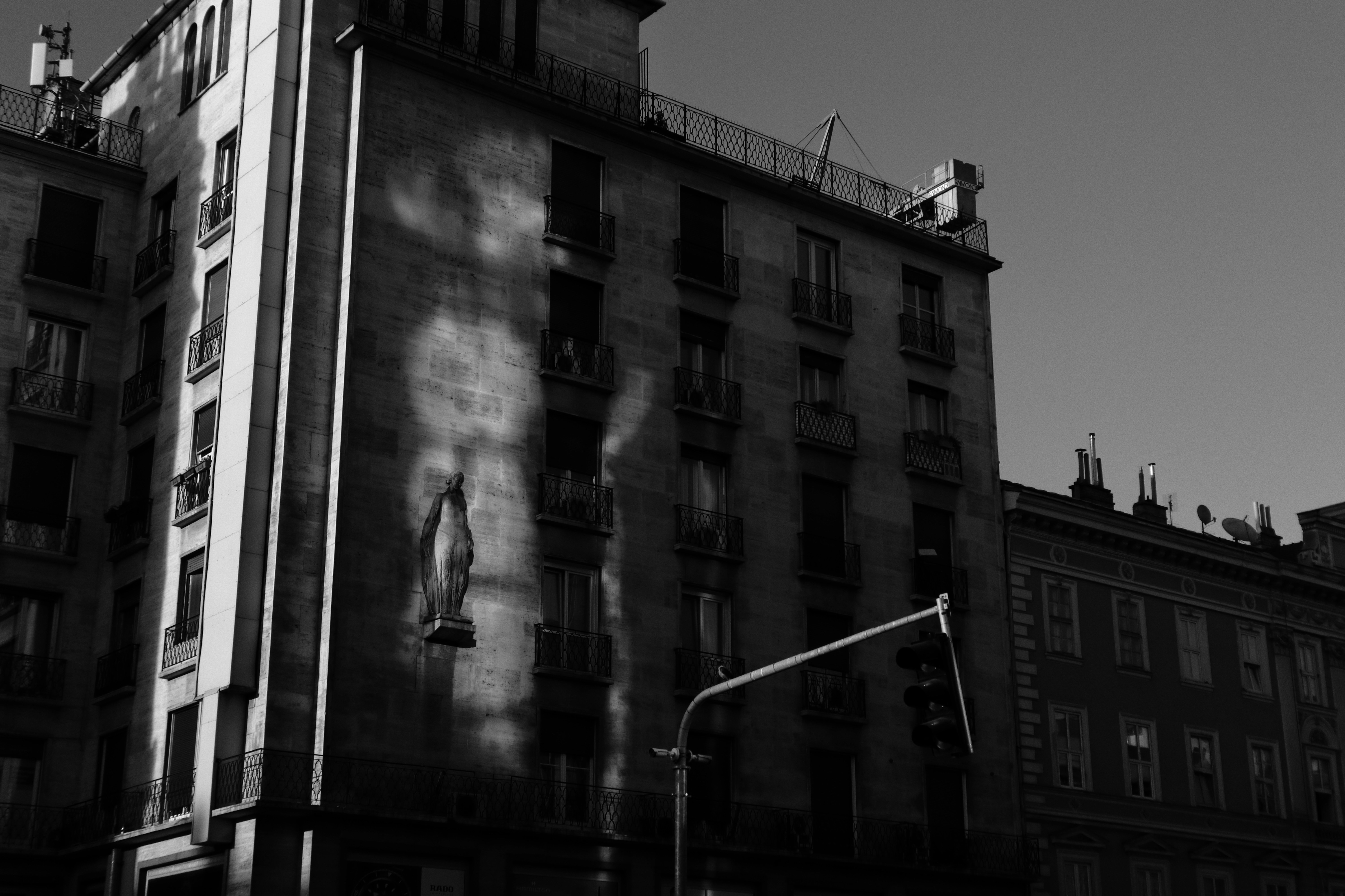 Sunlight reflects on old building facade.